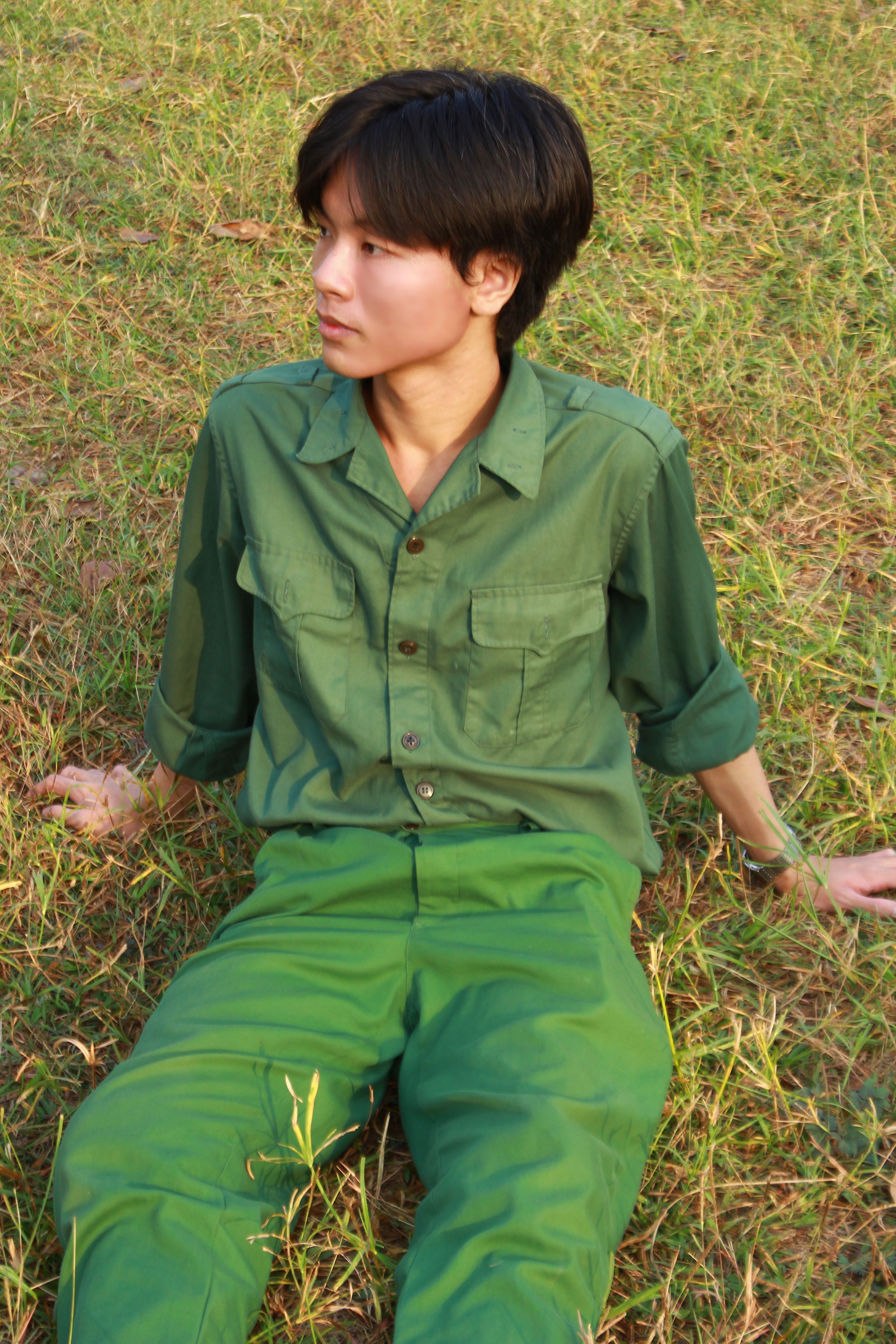 A Man in Green Sitting on the Grass · Free Stock Photo