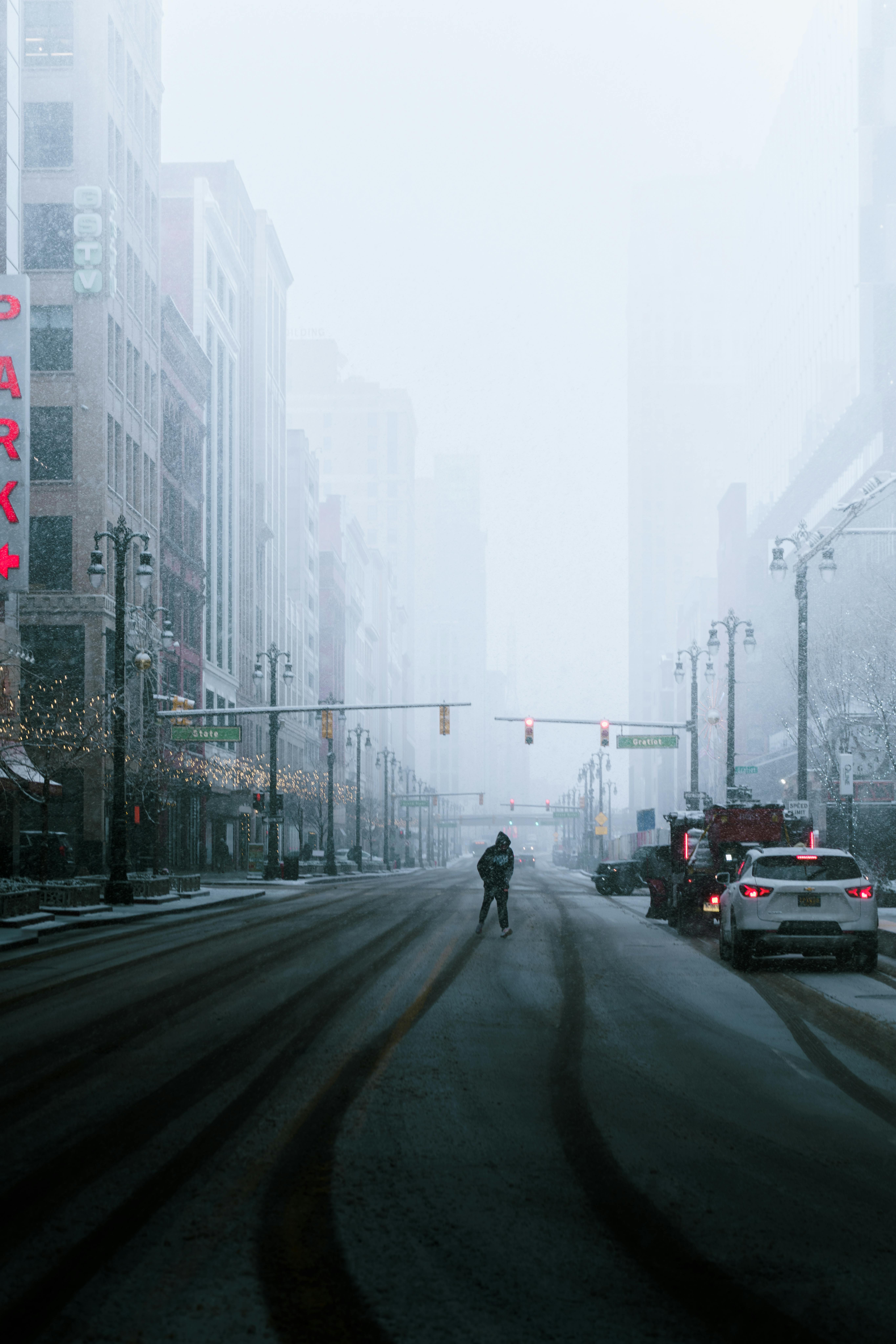 Passerby Walking Along the Street in a Snowstorm · Free Stock Photo
