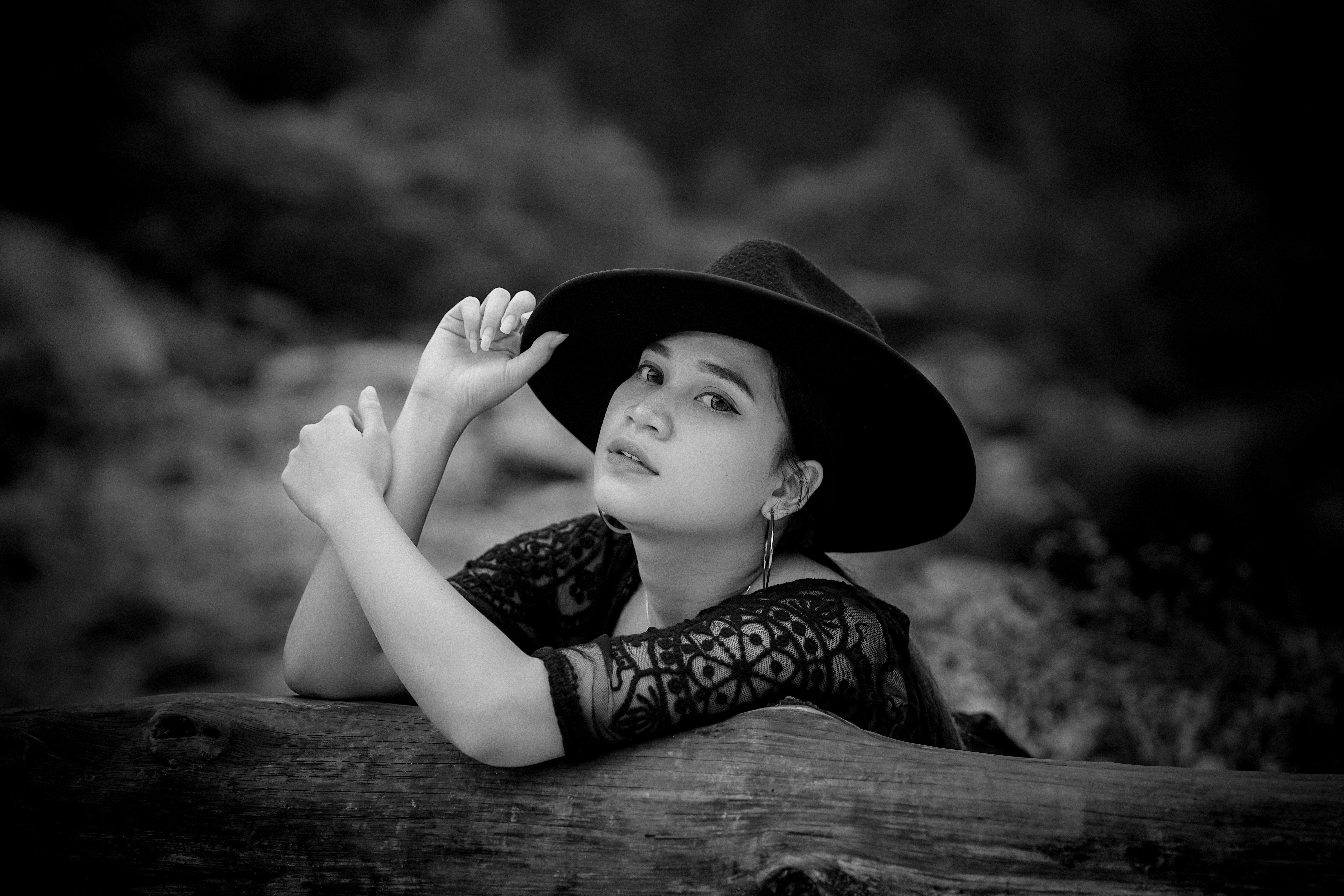 Elegant Woman in Hat Posing by Tree Log · Free Stock Photo