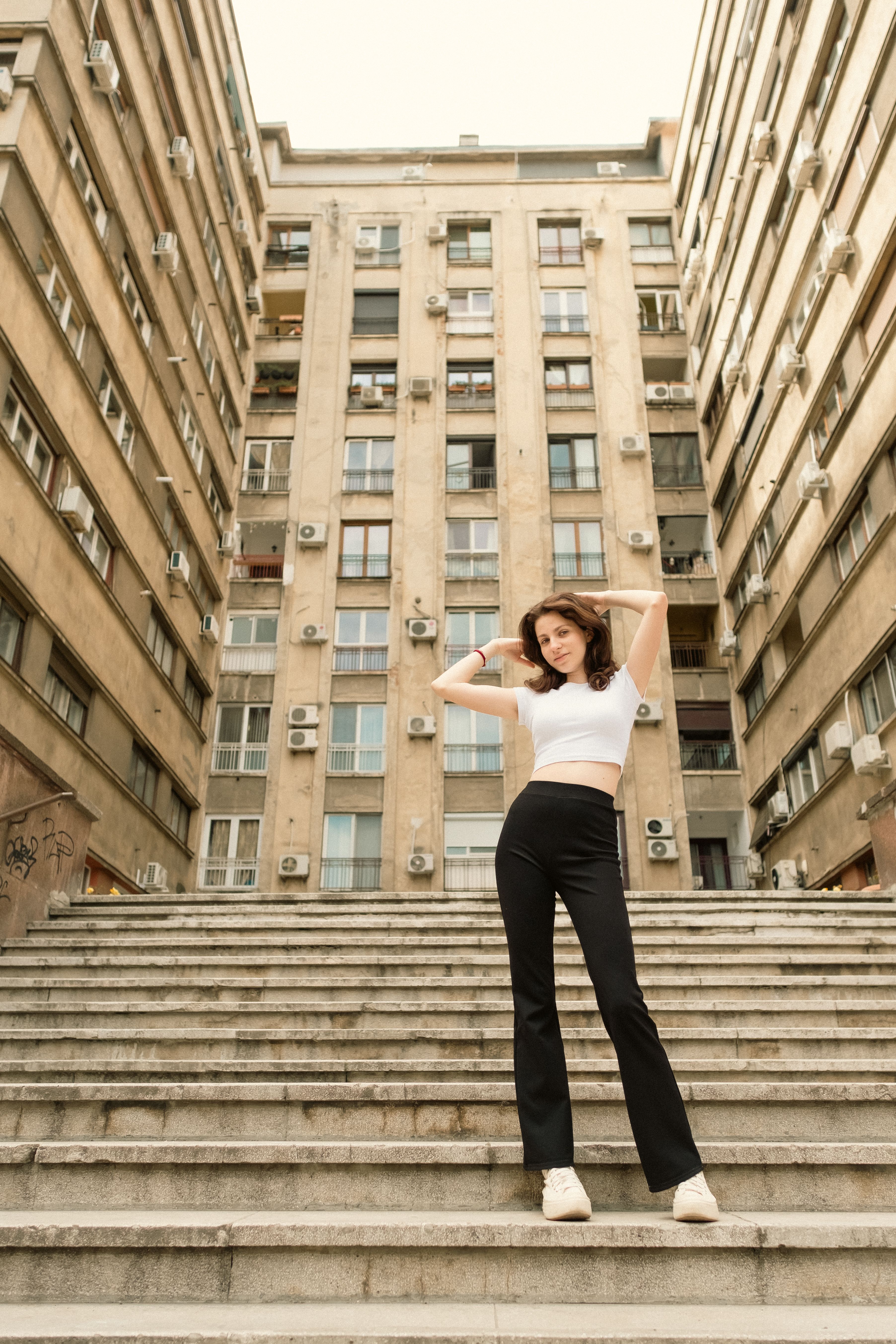 Woman Standing on Stairs with Residential Buildings around · Free Stock ...