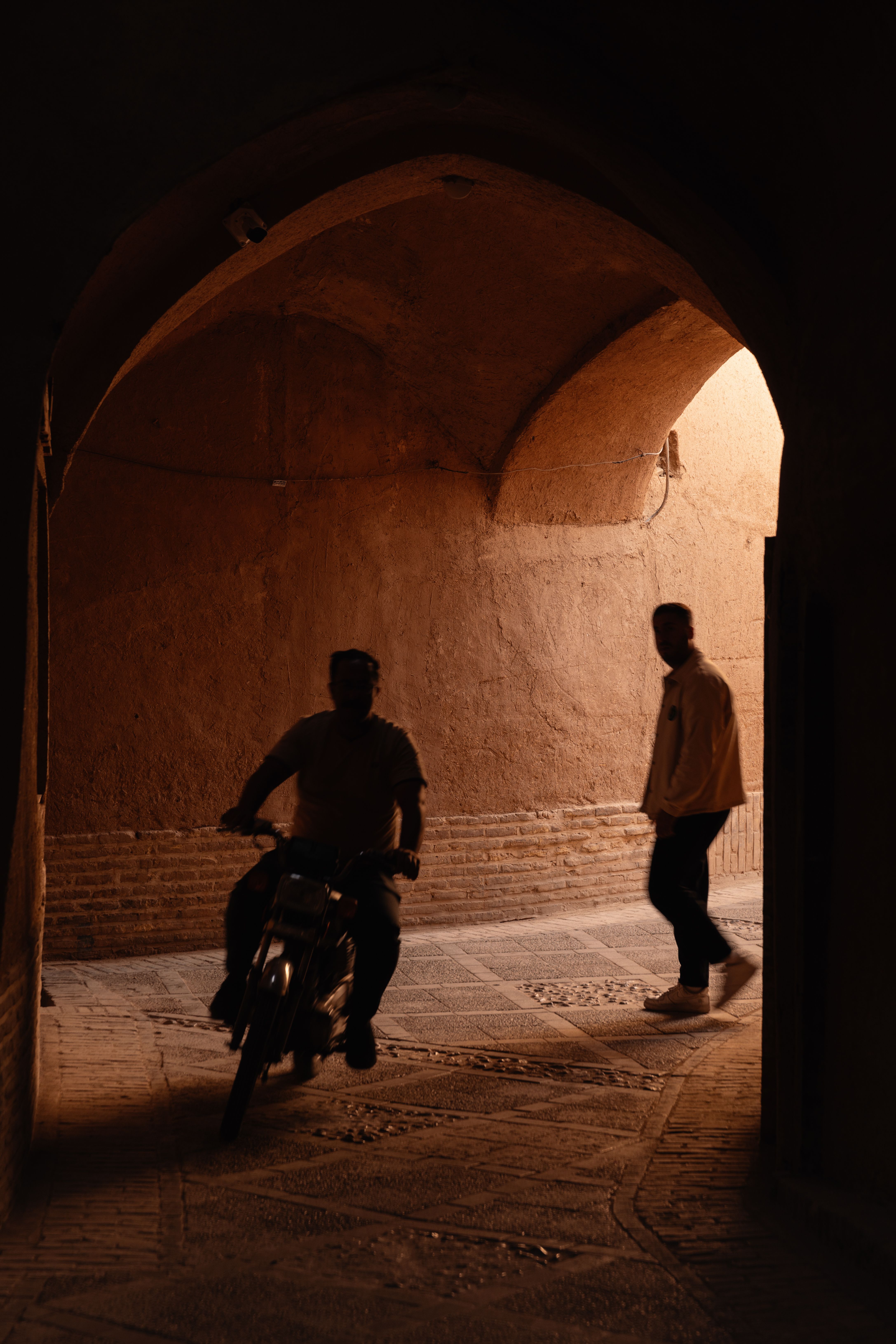 Men Walking and Riding Motorbike in Tunnel · Free Stock Photo