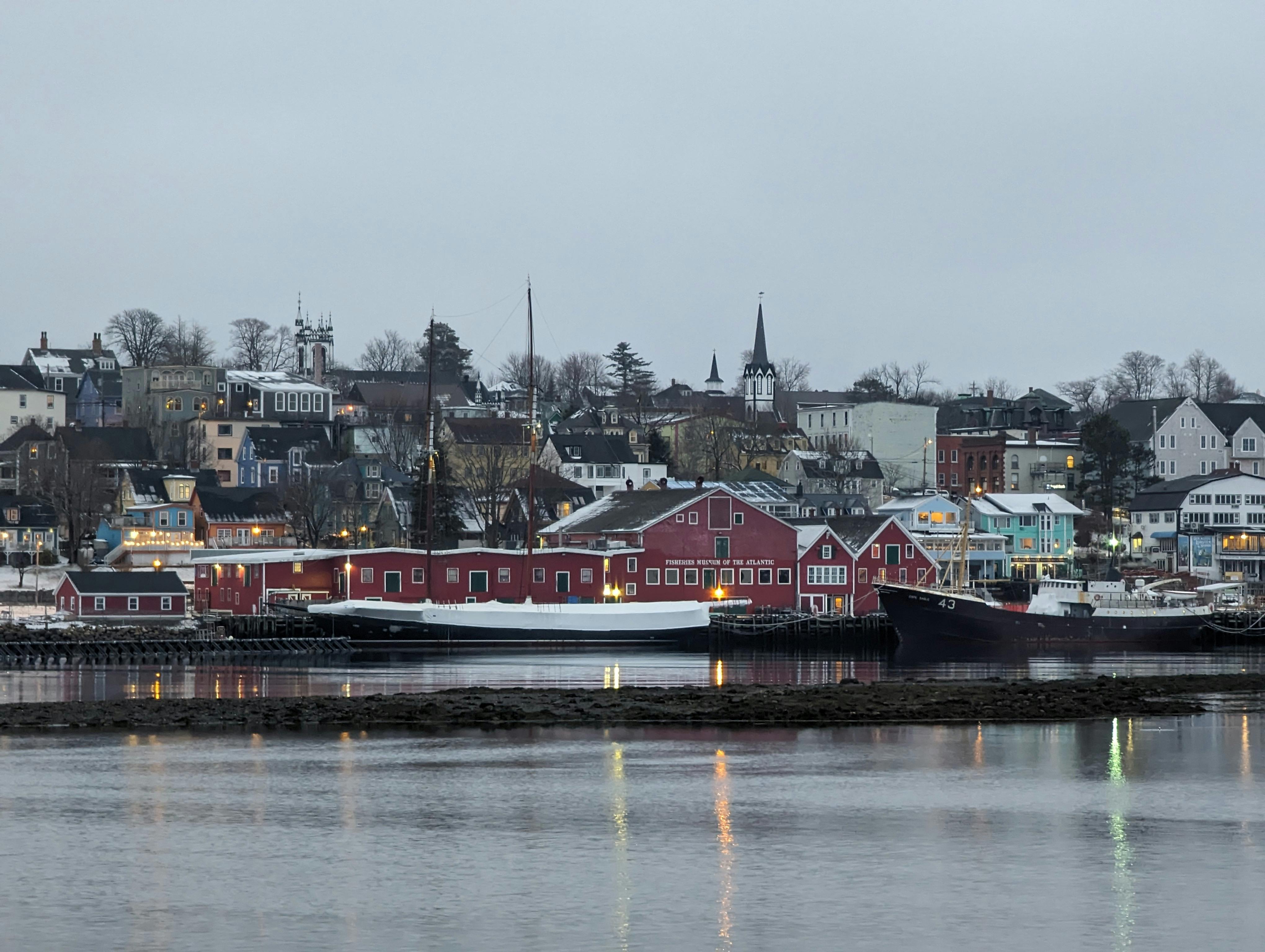 A view of a harbor with red buildings and a bridge · Free Stock Photo