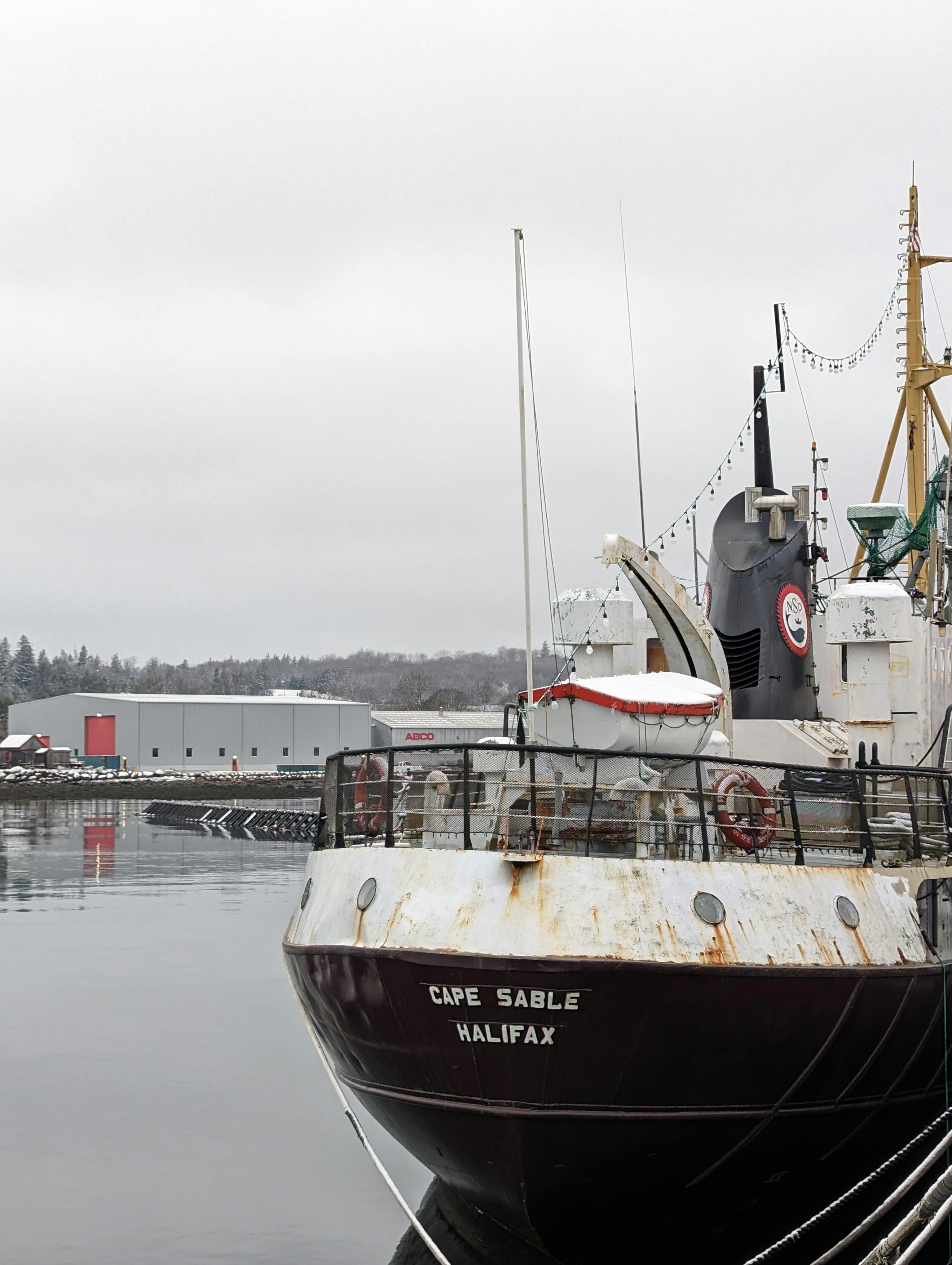 Stern of a Cape Sable Trawler Moored in Harbor · Free Stock Photo