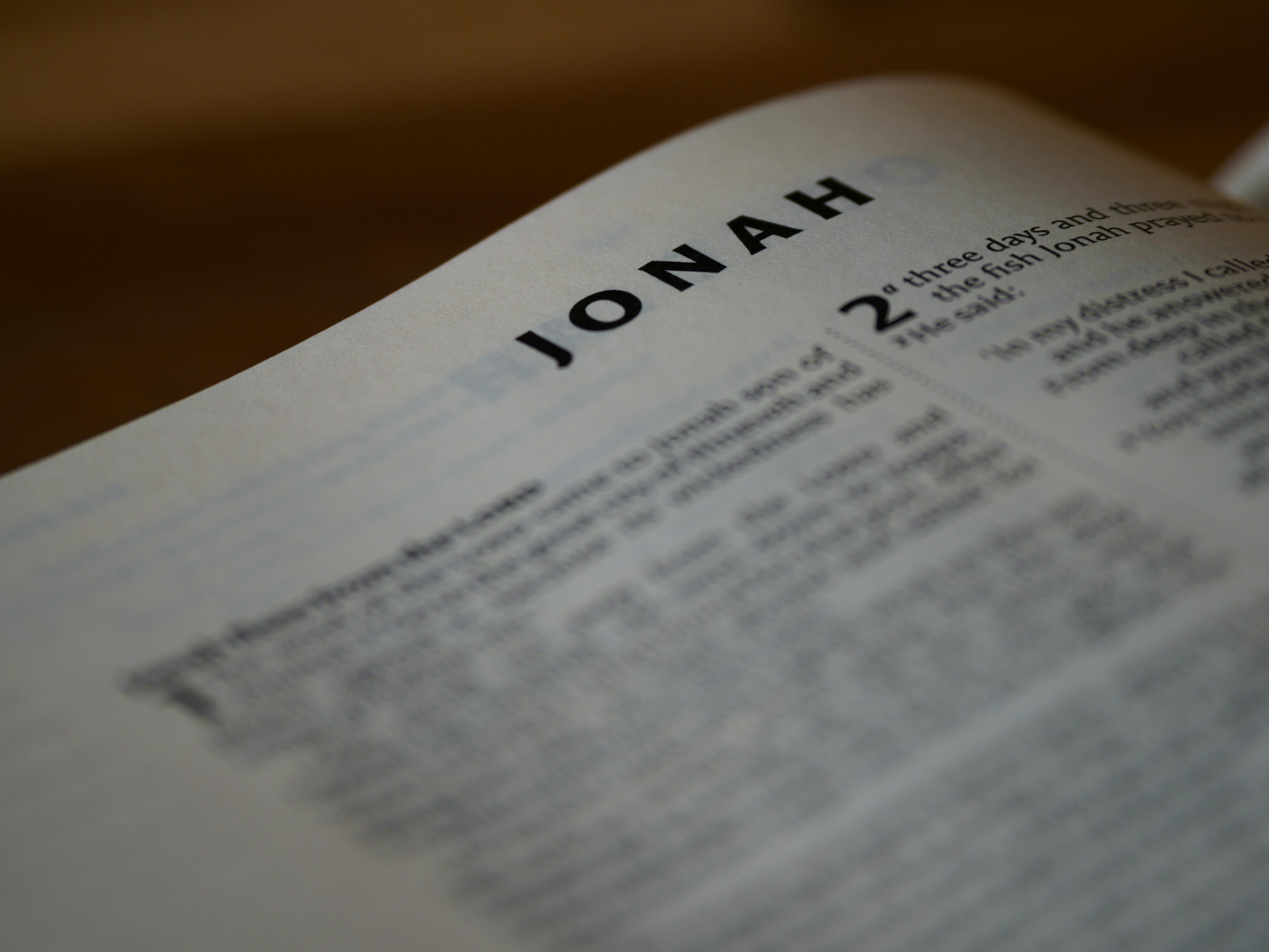 A close up of an open bible with the word jonah · Free Stock Photo