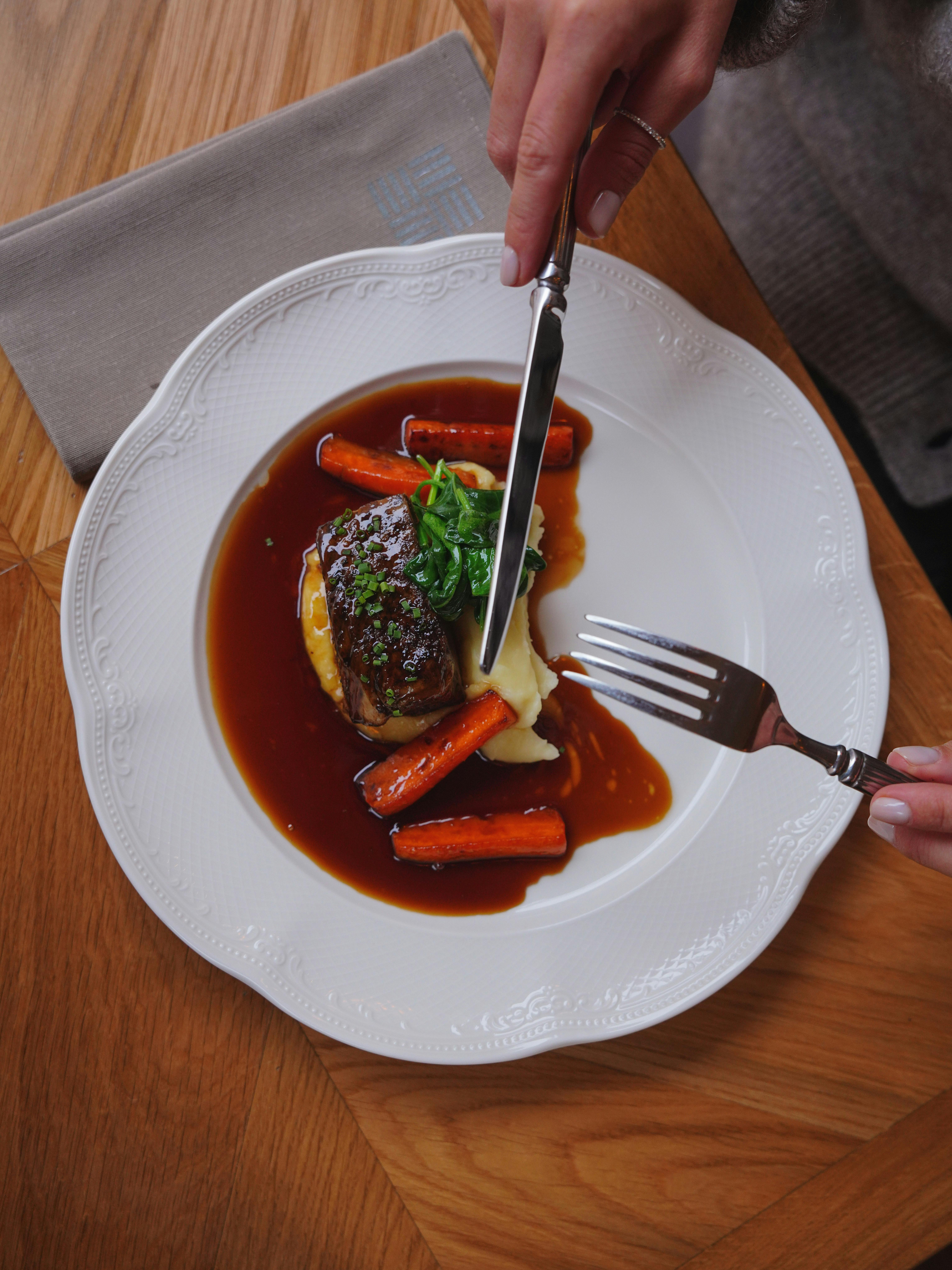 Person Using Fork While Eating · Free Stock Photo
