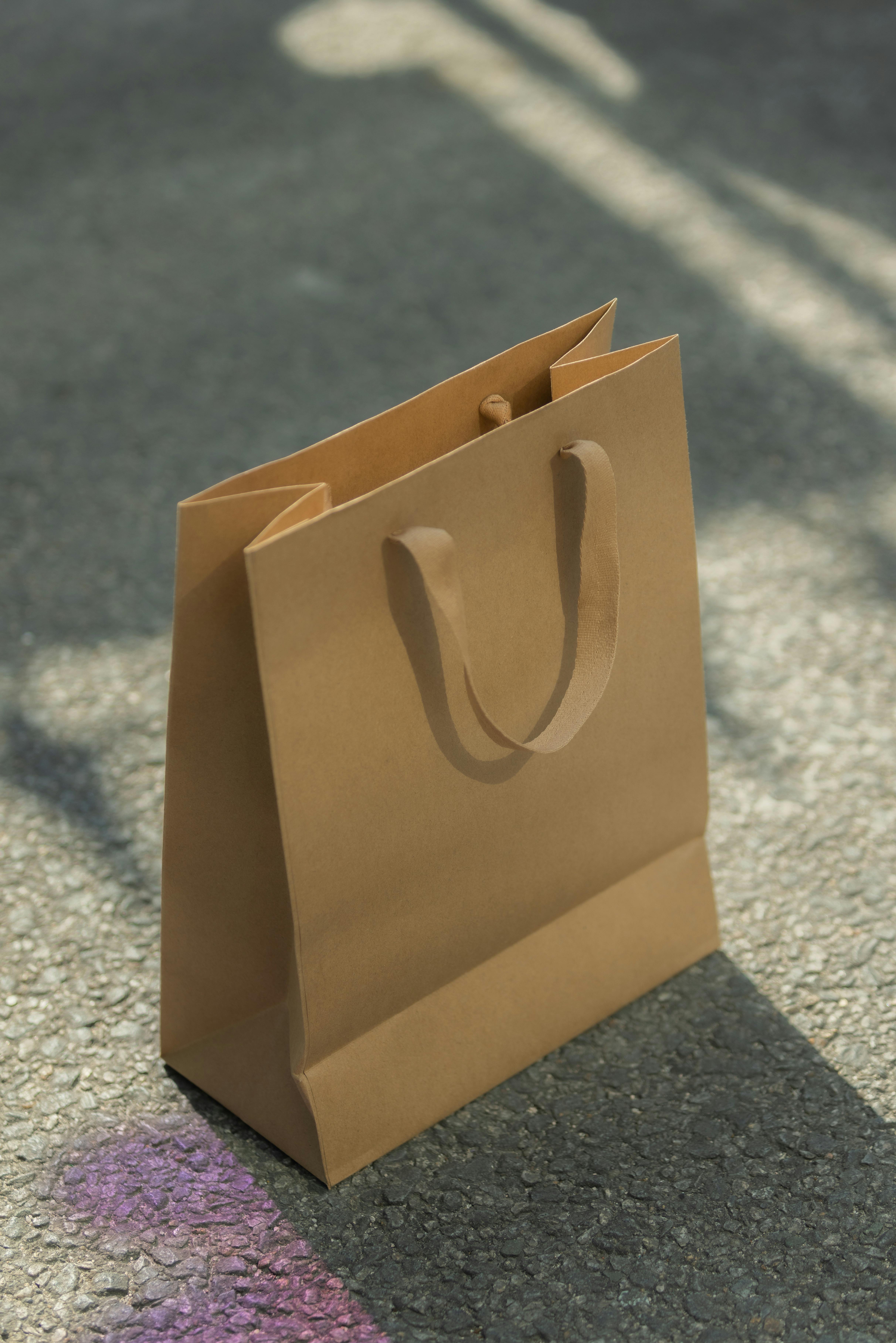 Close-up of a Paper Bag Standing on a Street · Free Stock Photo