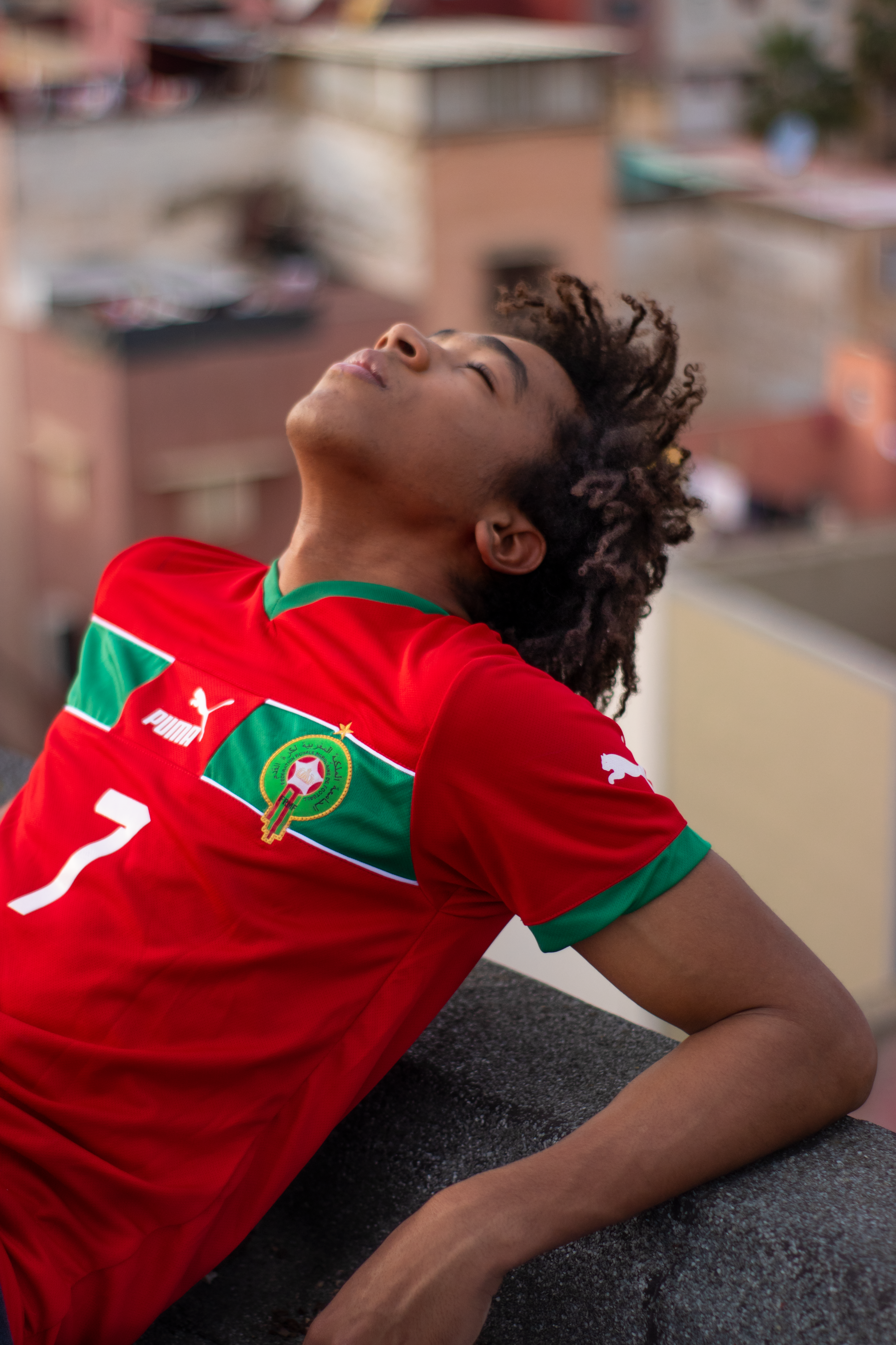 Man in Morocco Soccer Jersey Leaning on Wall · Free Stock Photo