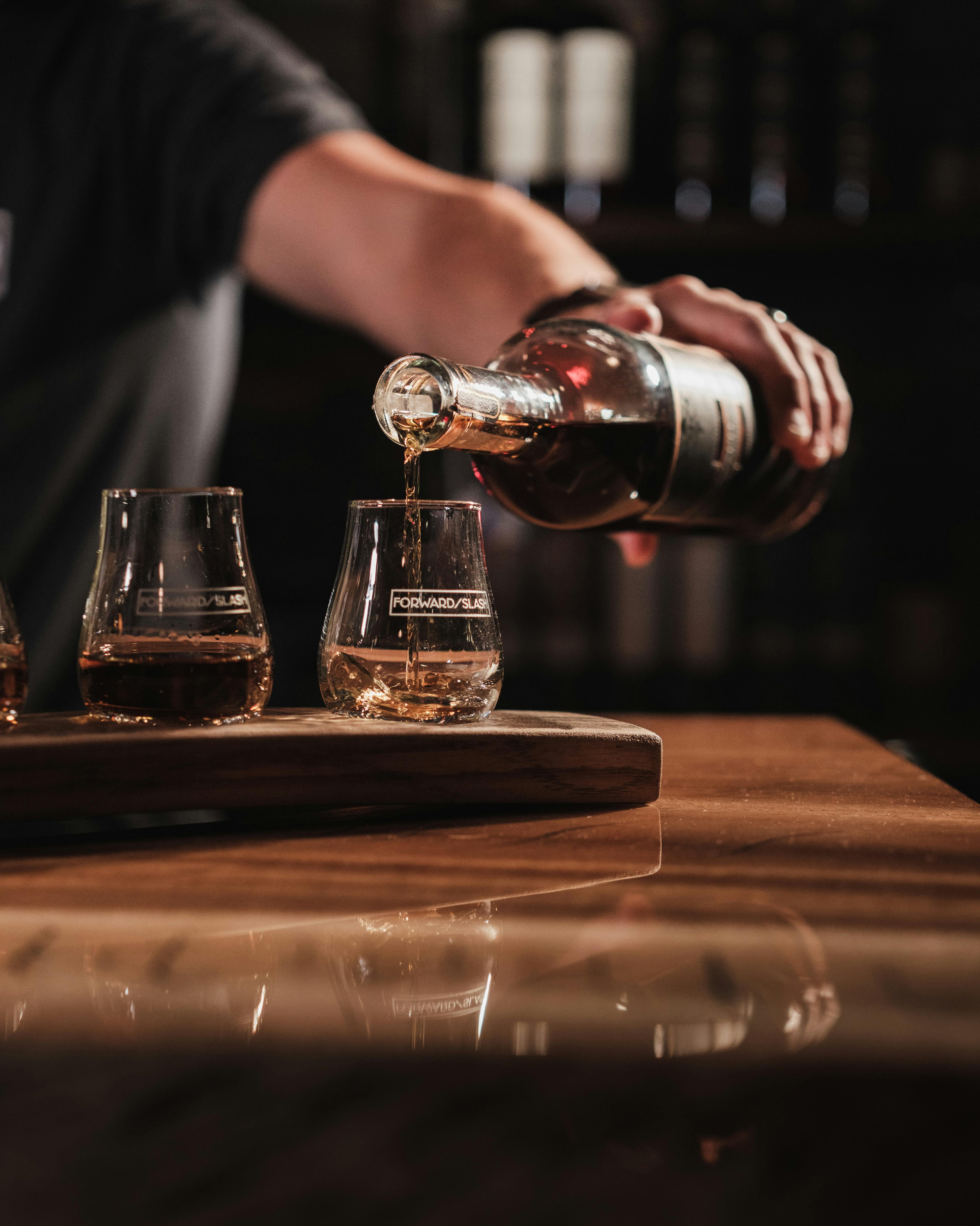 Barman Hand Pouring Drink · Free Stock Photo