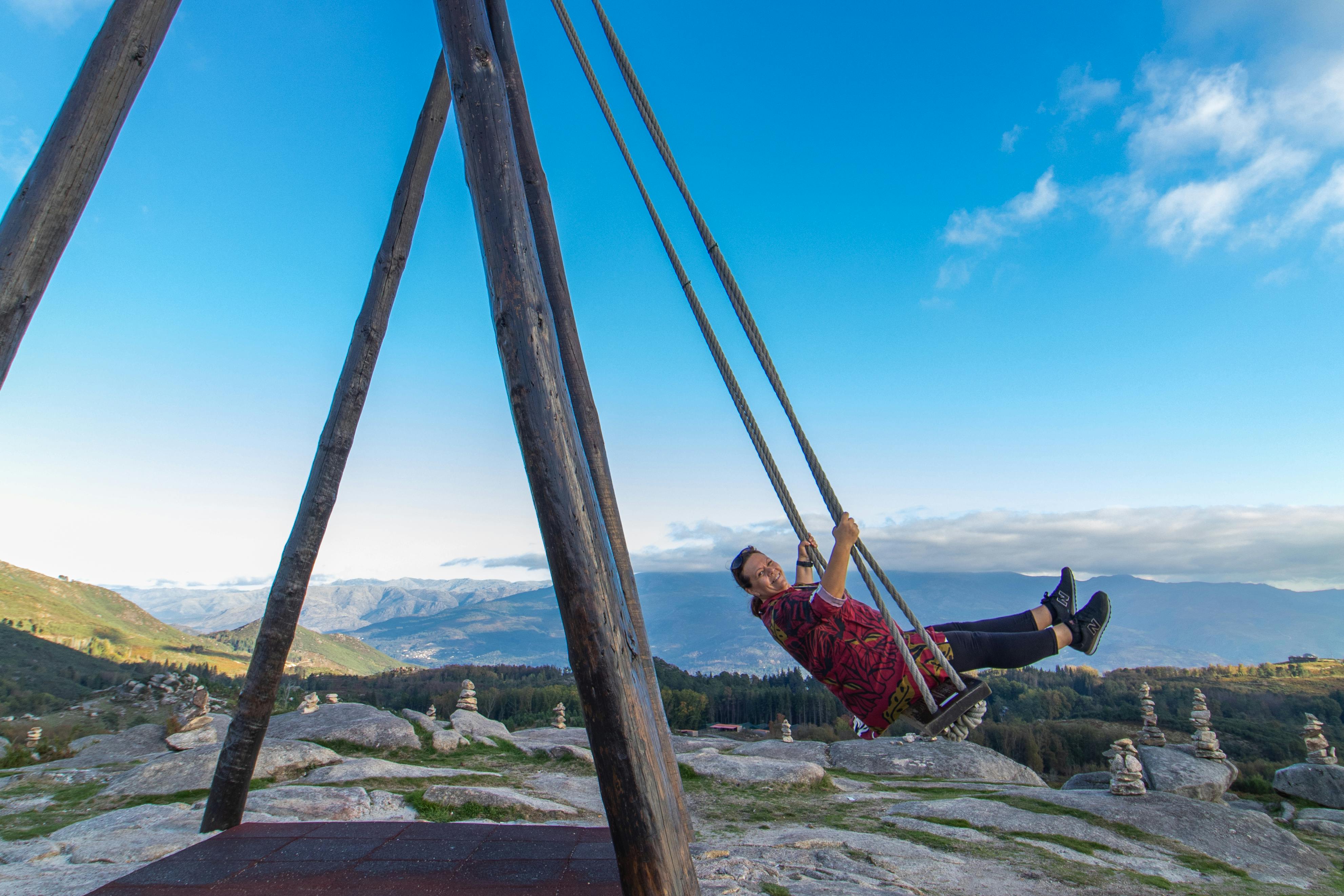 A person swinging on a swing in the mountains · Free Stock Photo