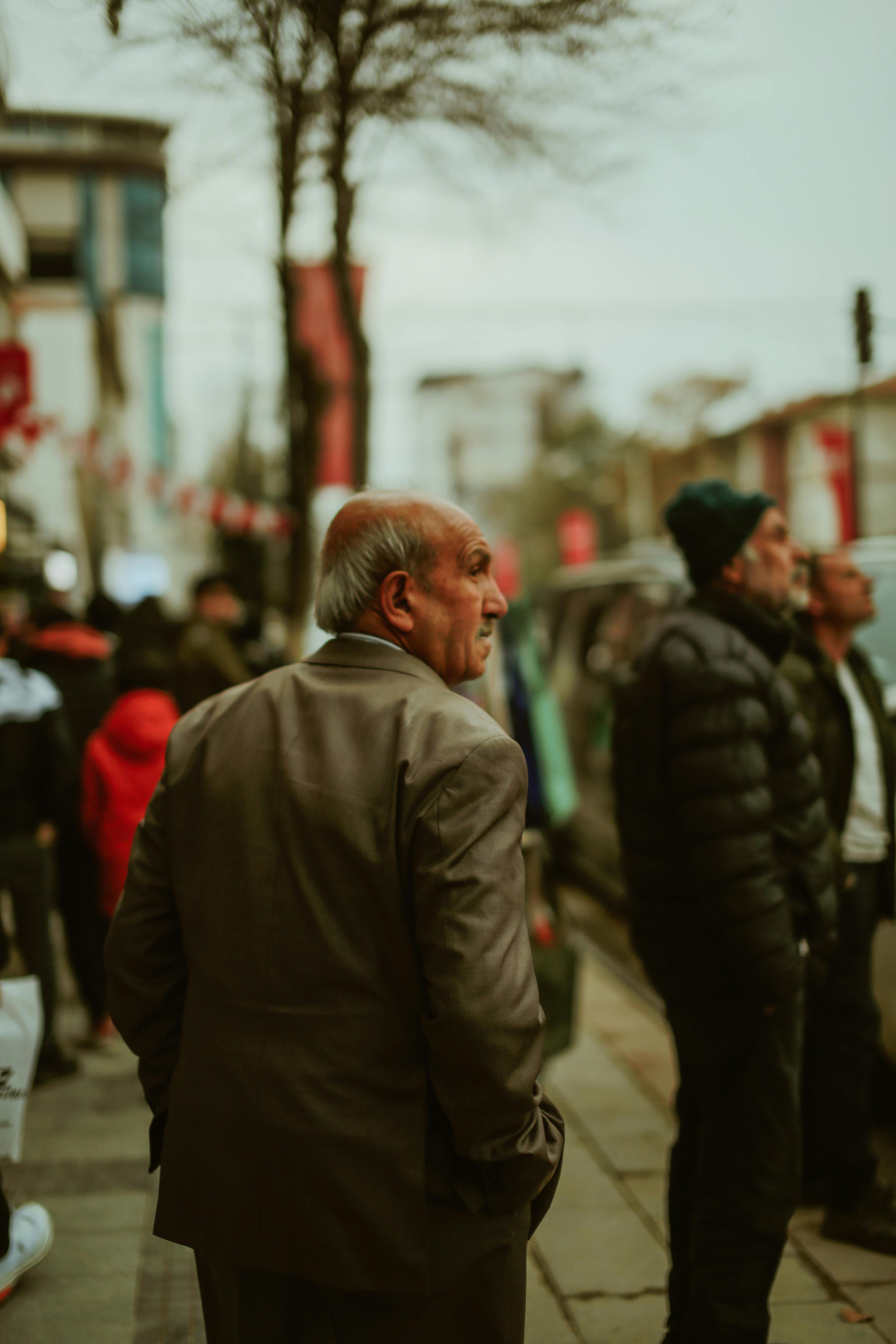 Back View of an Elderly Man Walking on a Sidewalk · Free Stock Photo