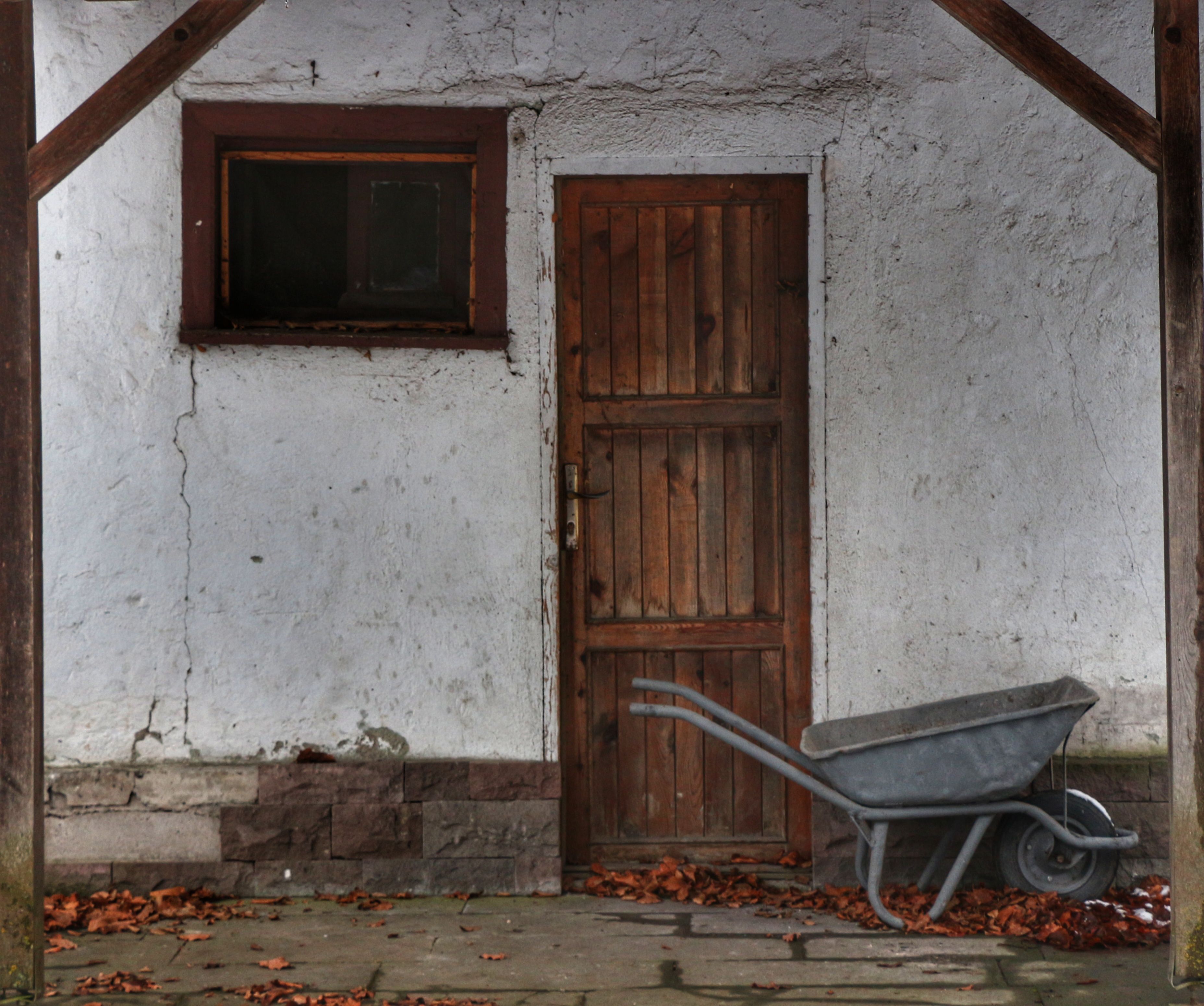Wheelbarrow by Barn Entrance · Free Stock Photo