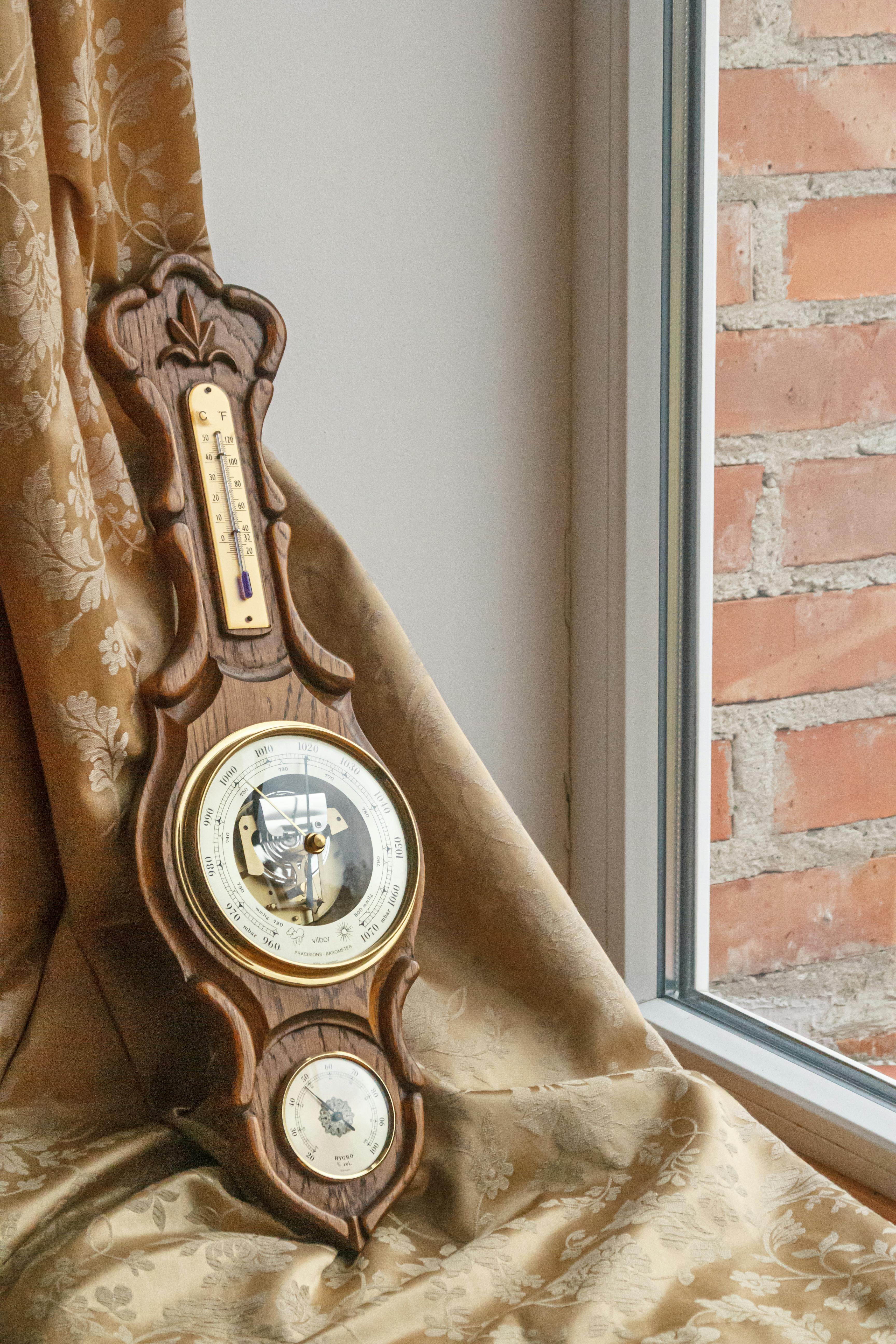 A Brown Barometer on a Golden Curtain · Free Stock Photo