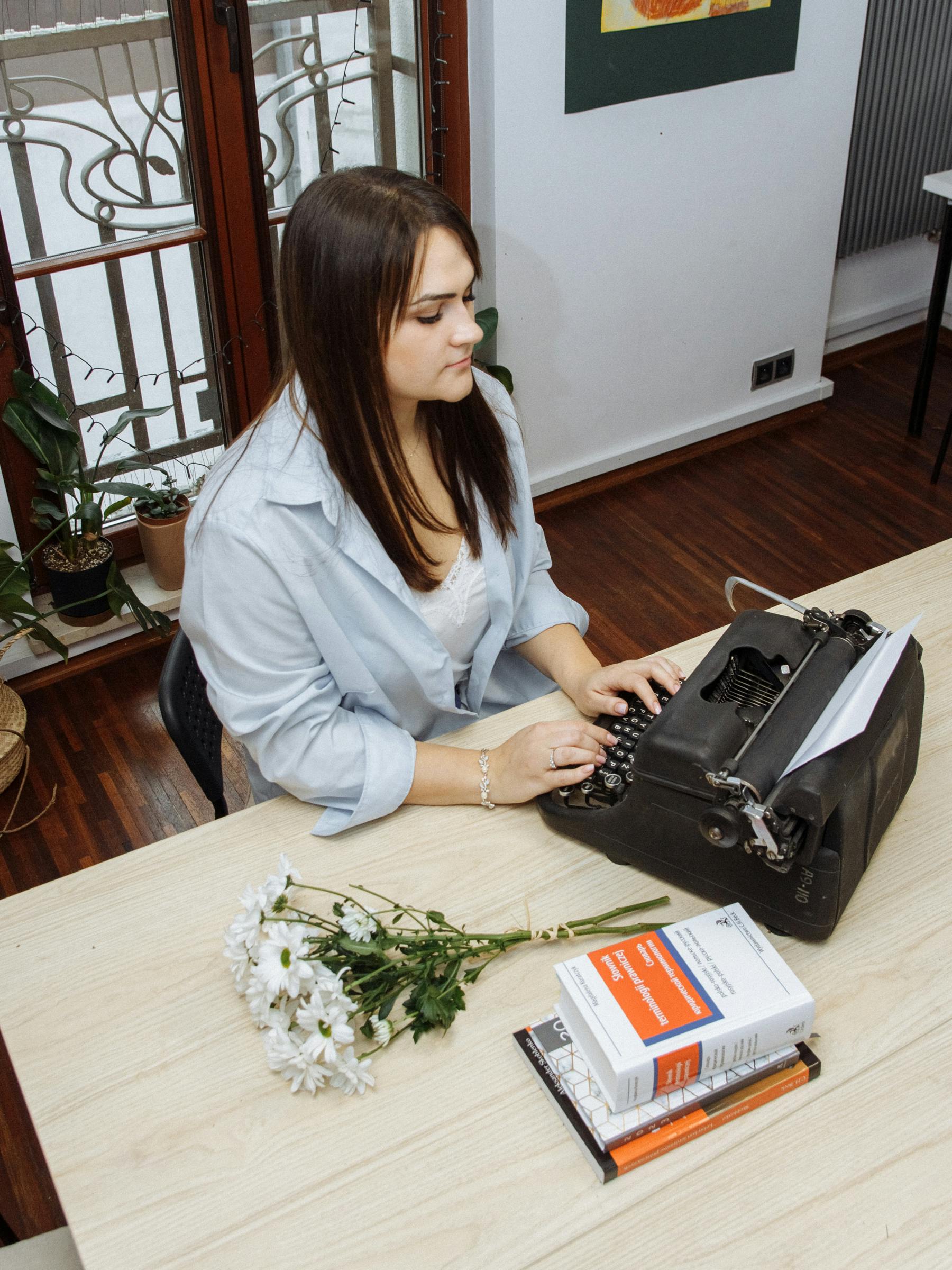 Woman Working on Typewriter · Free Stock Photo