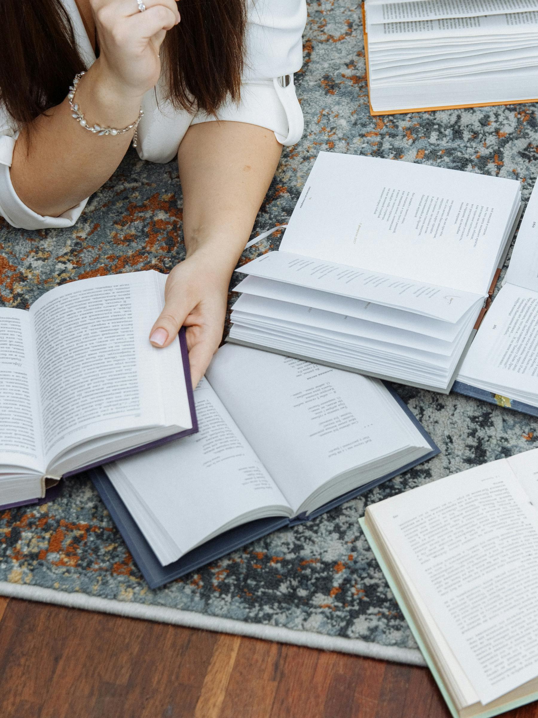 Woman Hands over Books on Floor · Free Stock Photo