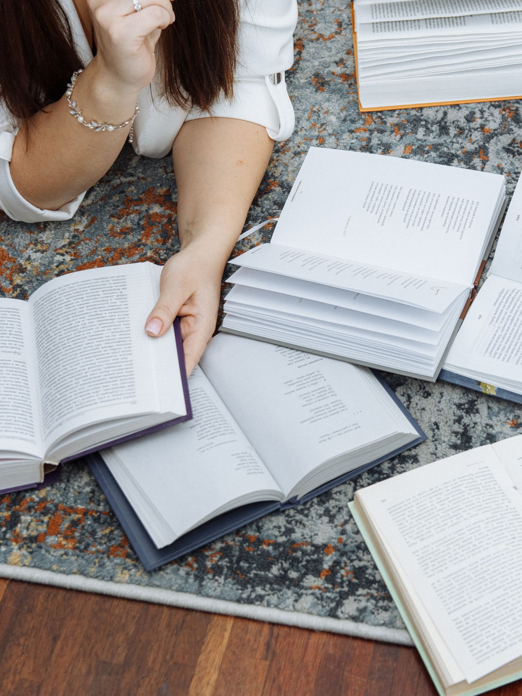 Woman Hands over Books on Floor · Free Stock Photo