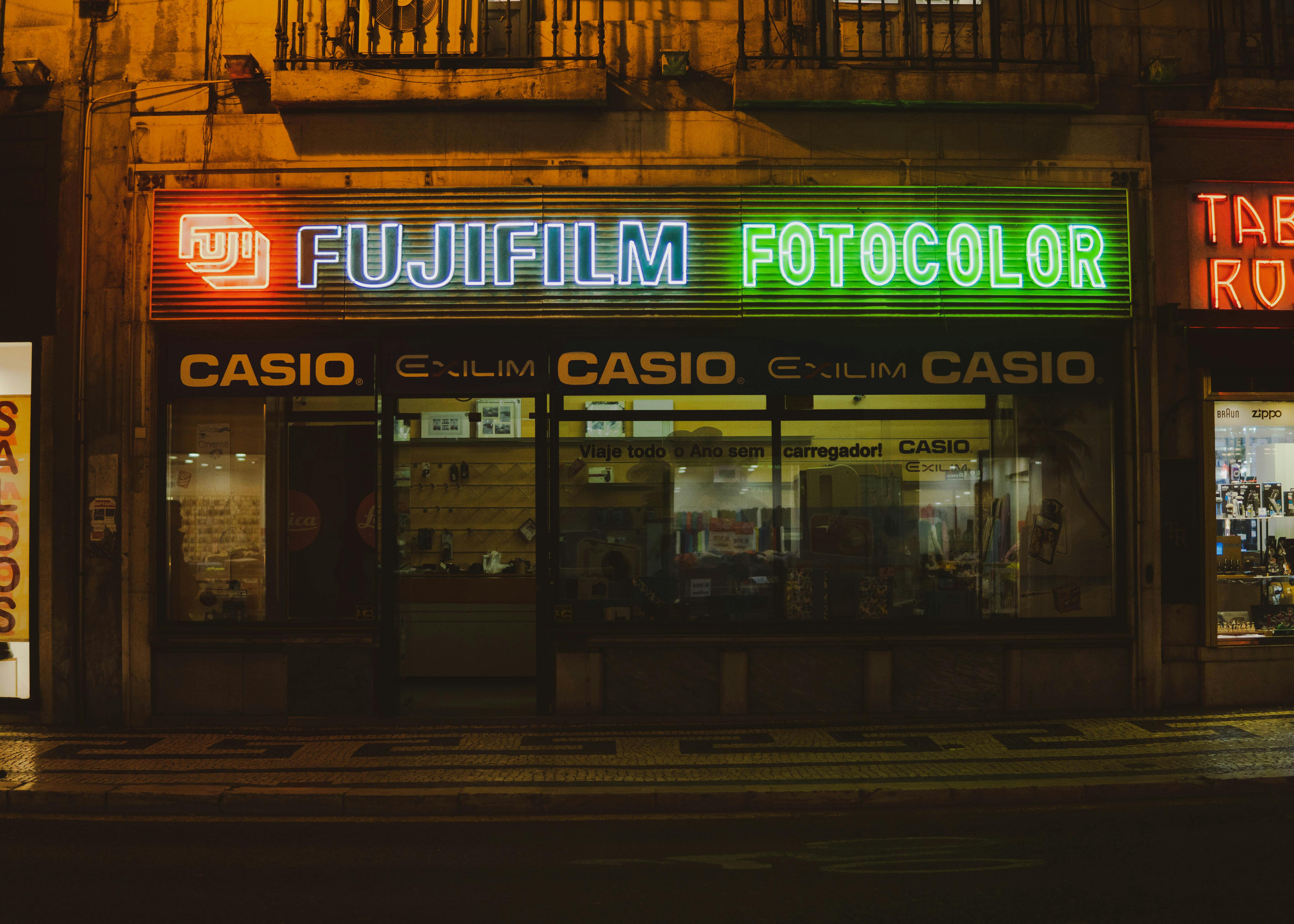 Neon Lights on Store Wall at Night · Free Stock Photo