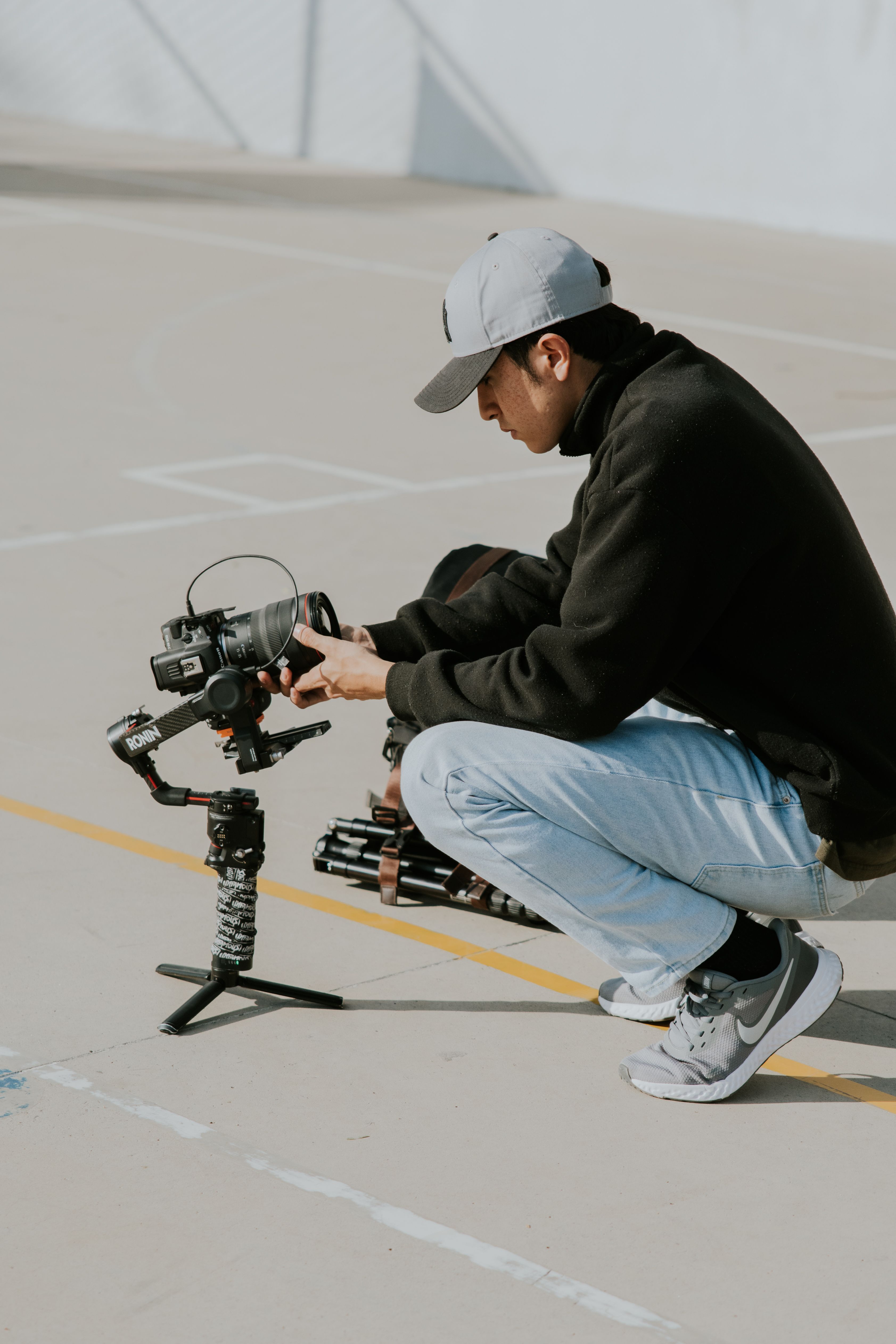 Man Squatting with Camera · Free Stock Photo