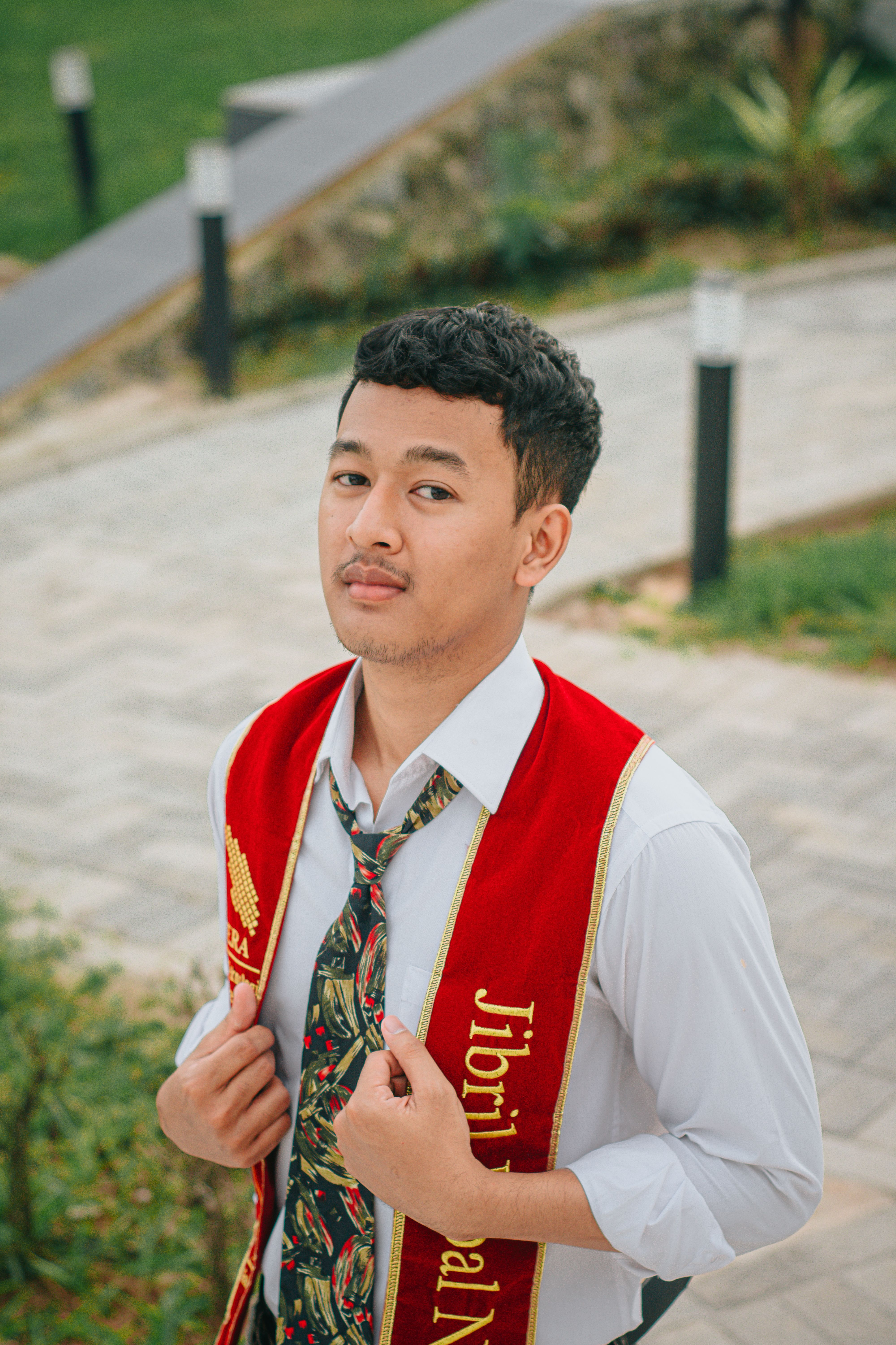 Young Man in a Red Sash and Tie · Free Stock Photo
