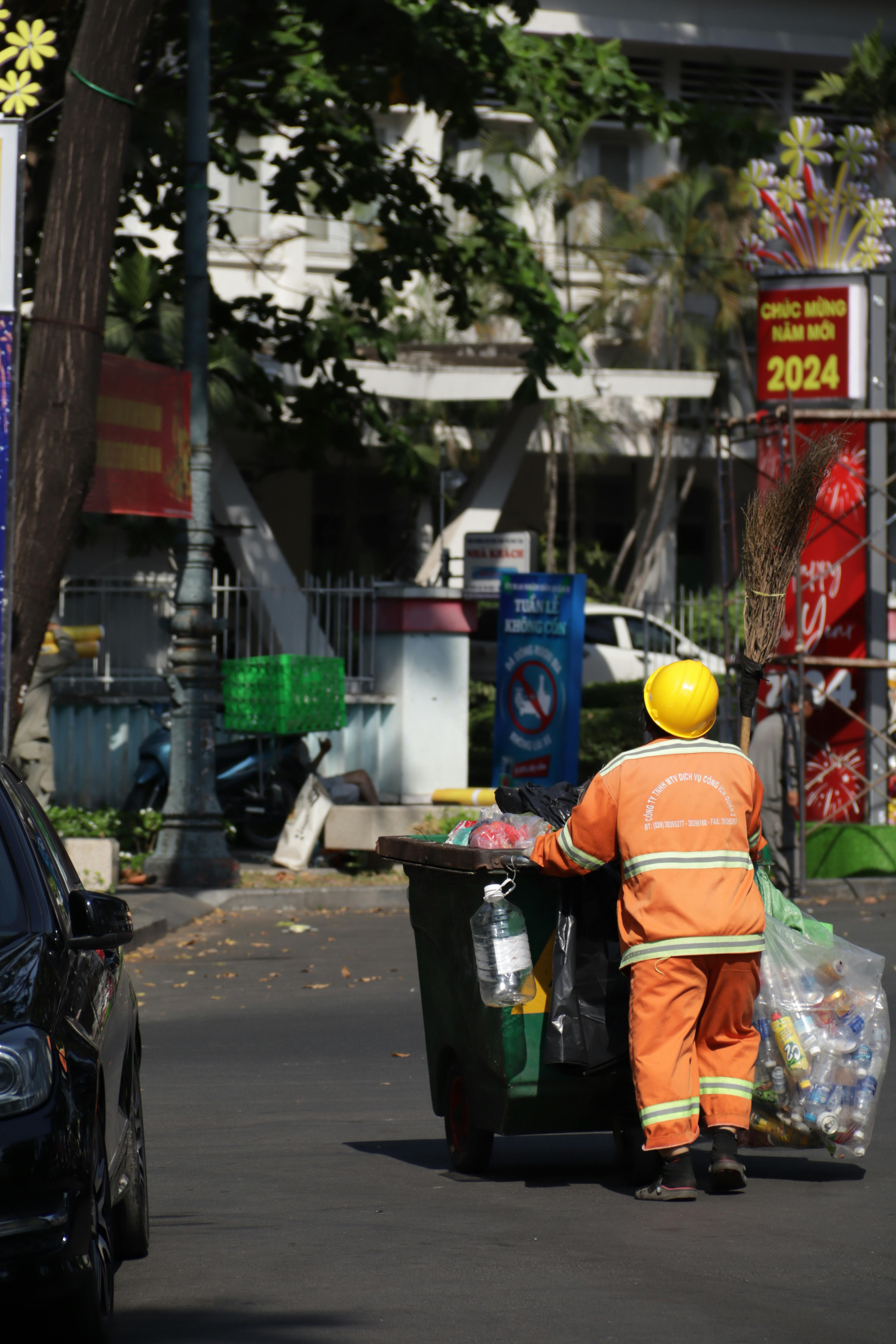 Dustman Walking with Garbage Bin on Street · Free Stock Photo