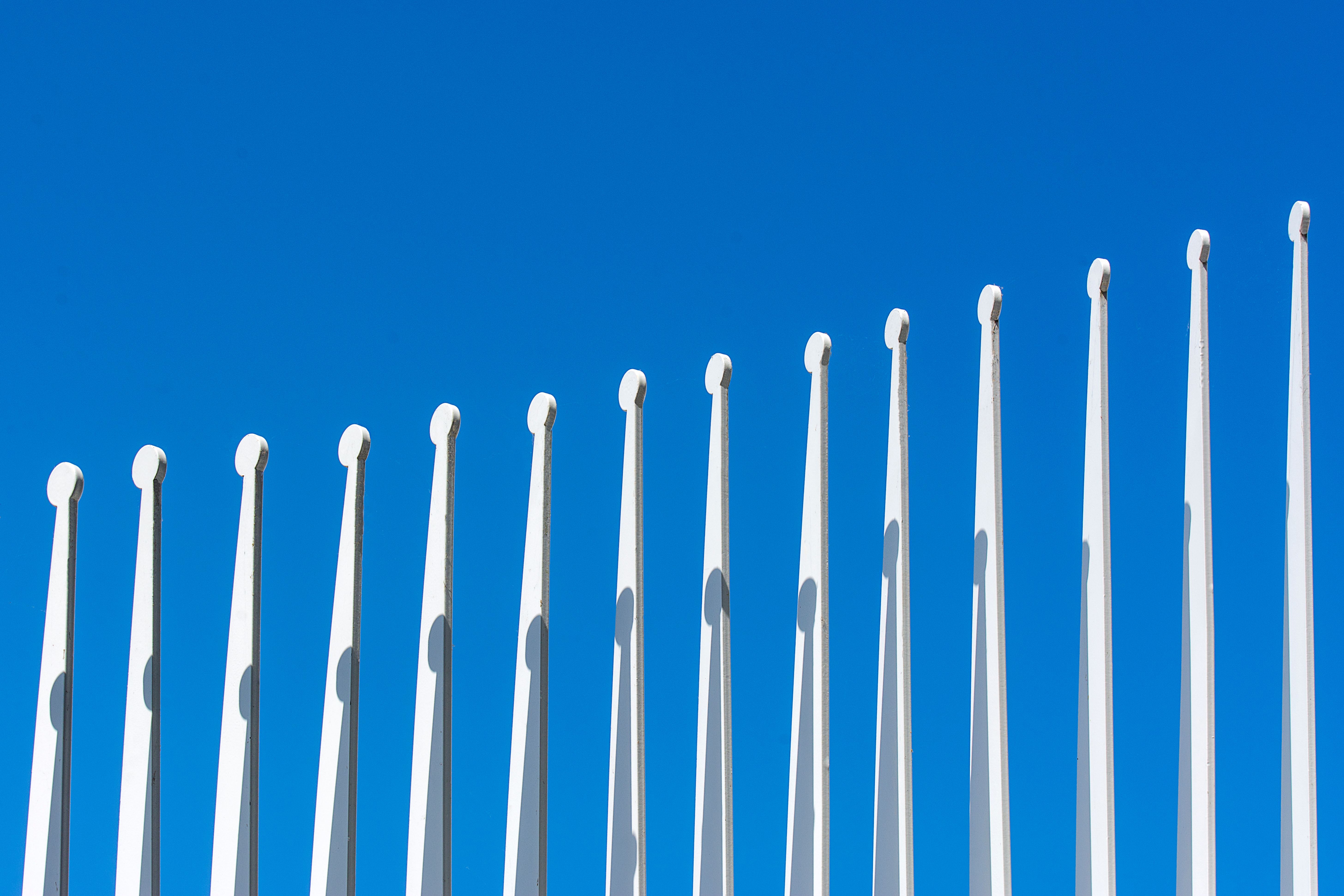 Row of White Poles under Clear Sky · Free Stock Photo