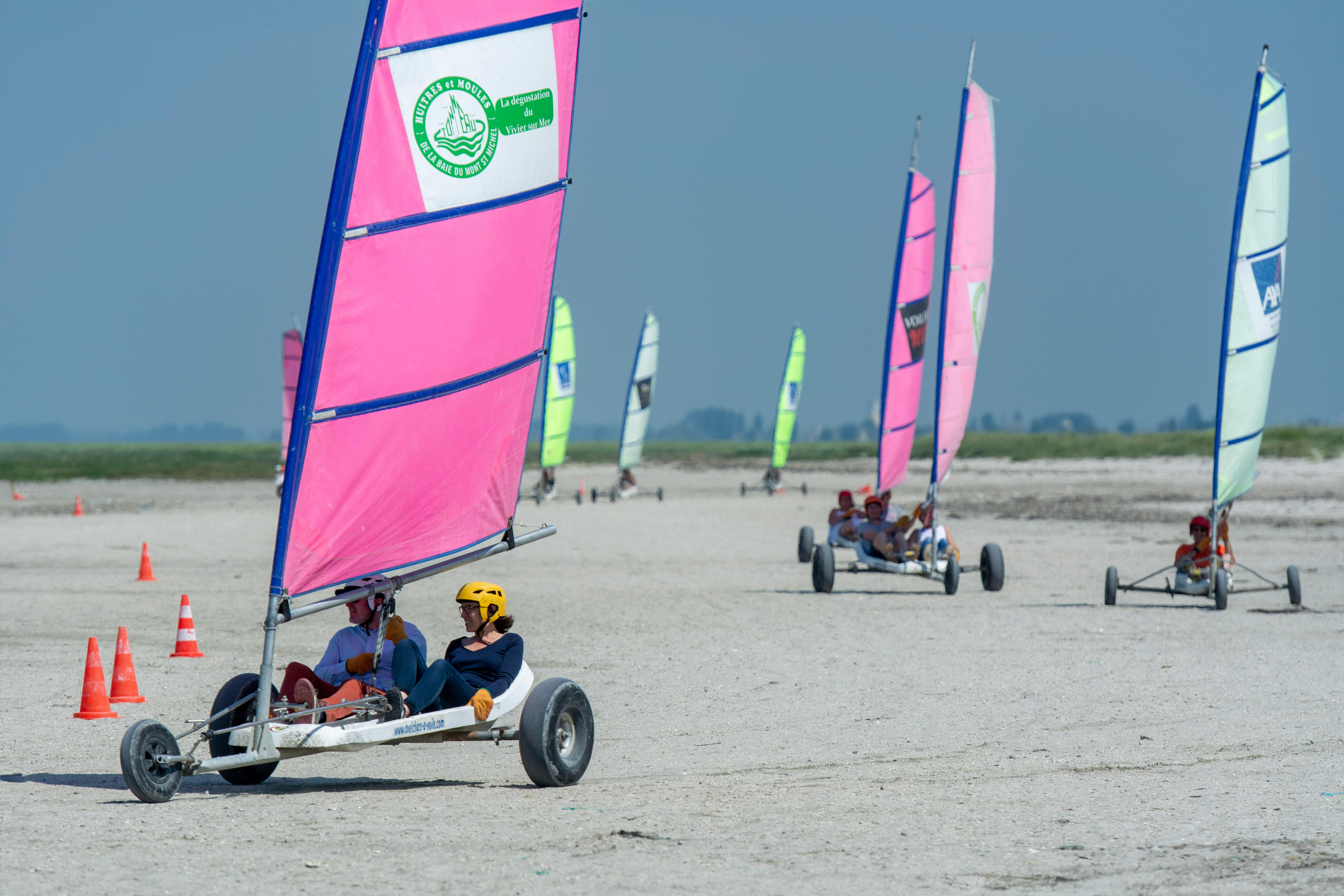 People Riding Bikes with Sails on Beach · Free Stock Photo