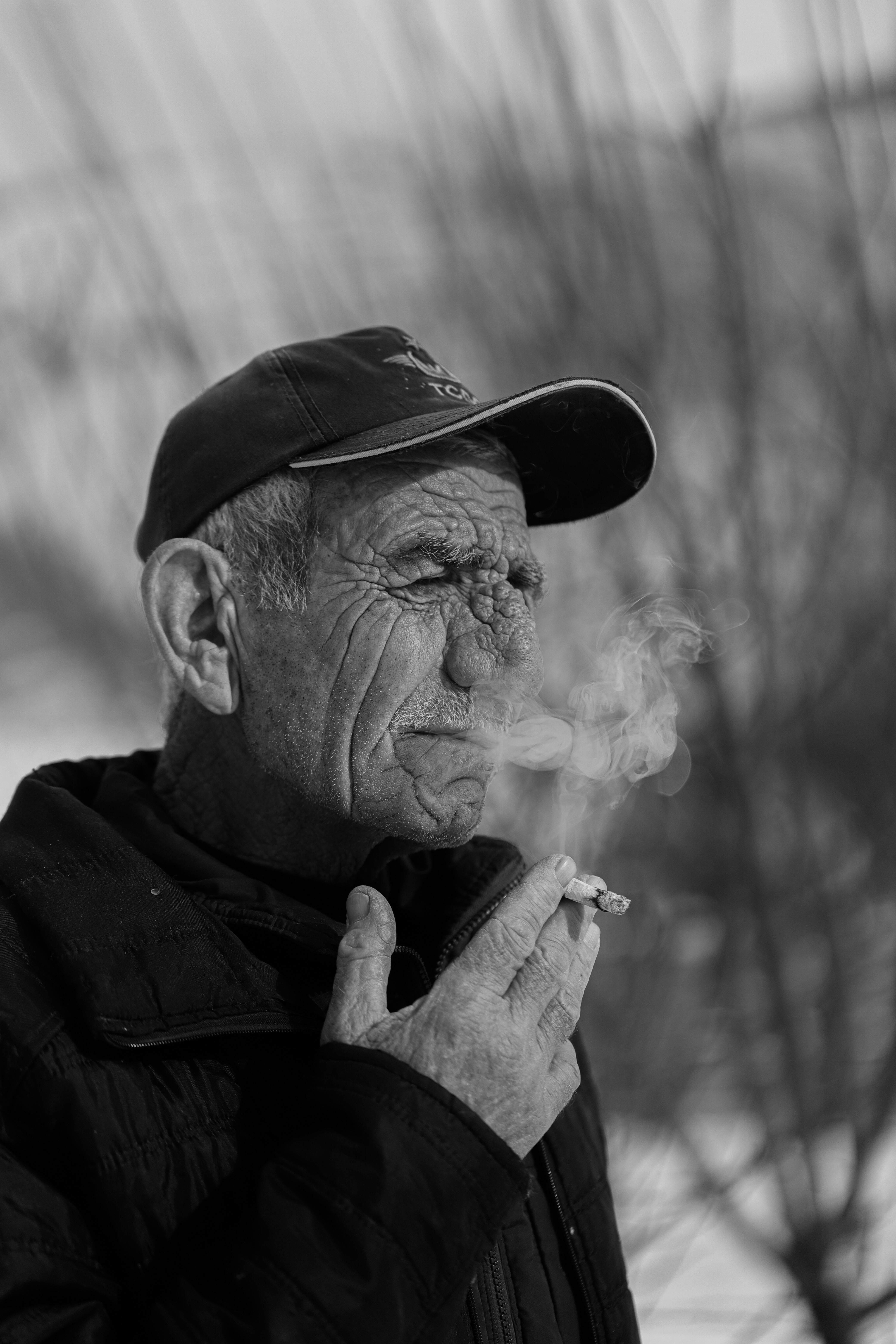 Elderly Man Smoking a Cigarette in Black and White · Free Stock Photo