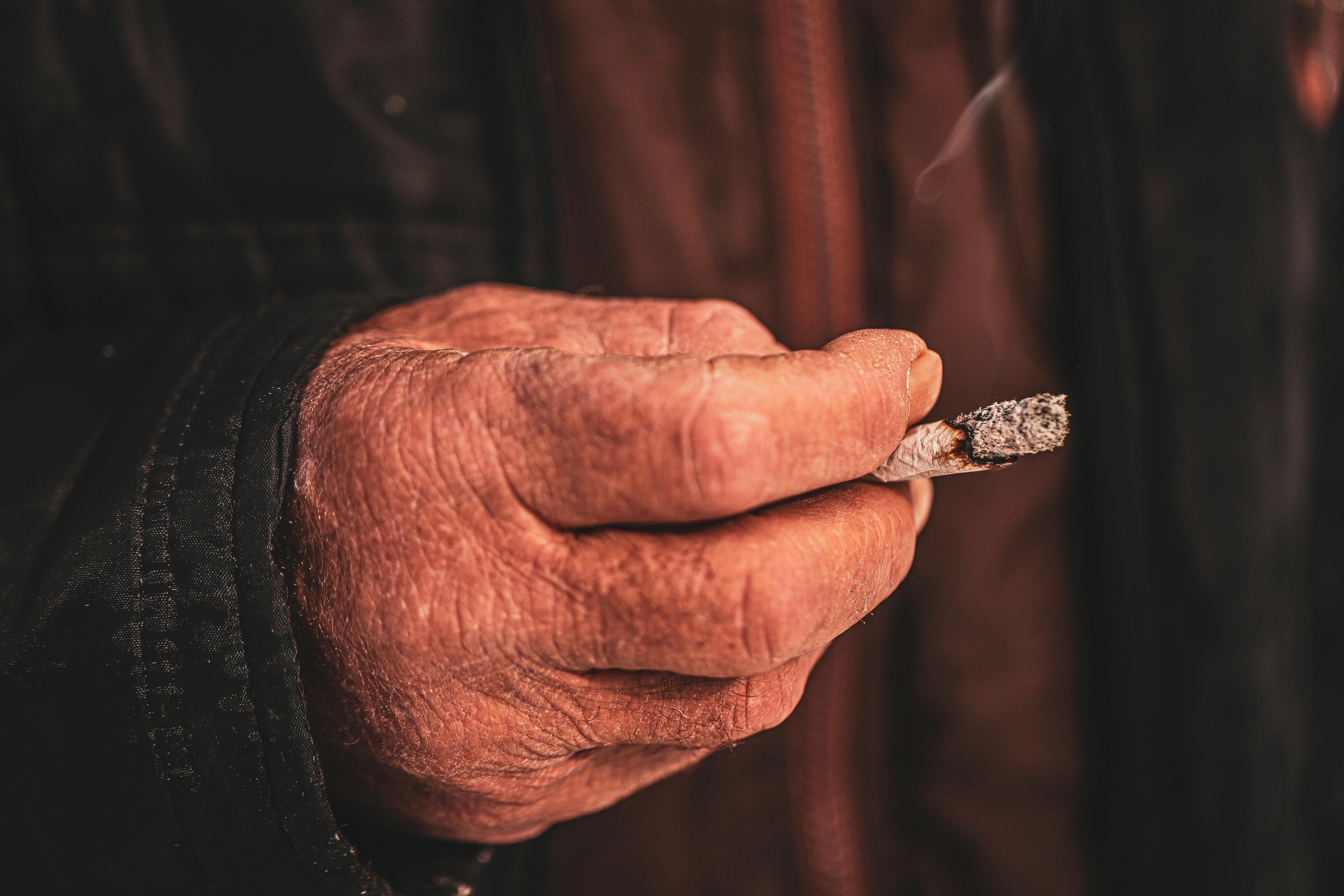 Elderly Man Smoking a Cigarette · Free Stock Photo