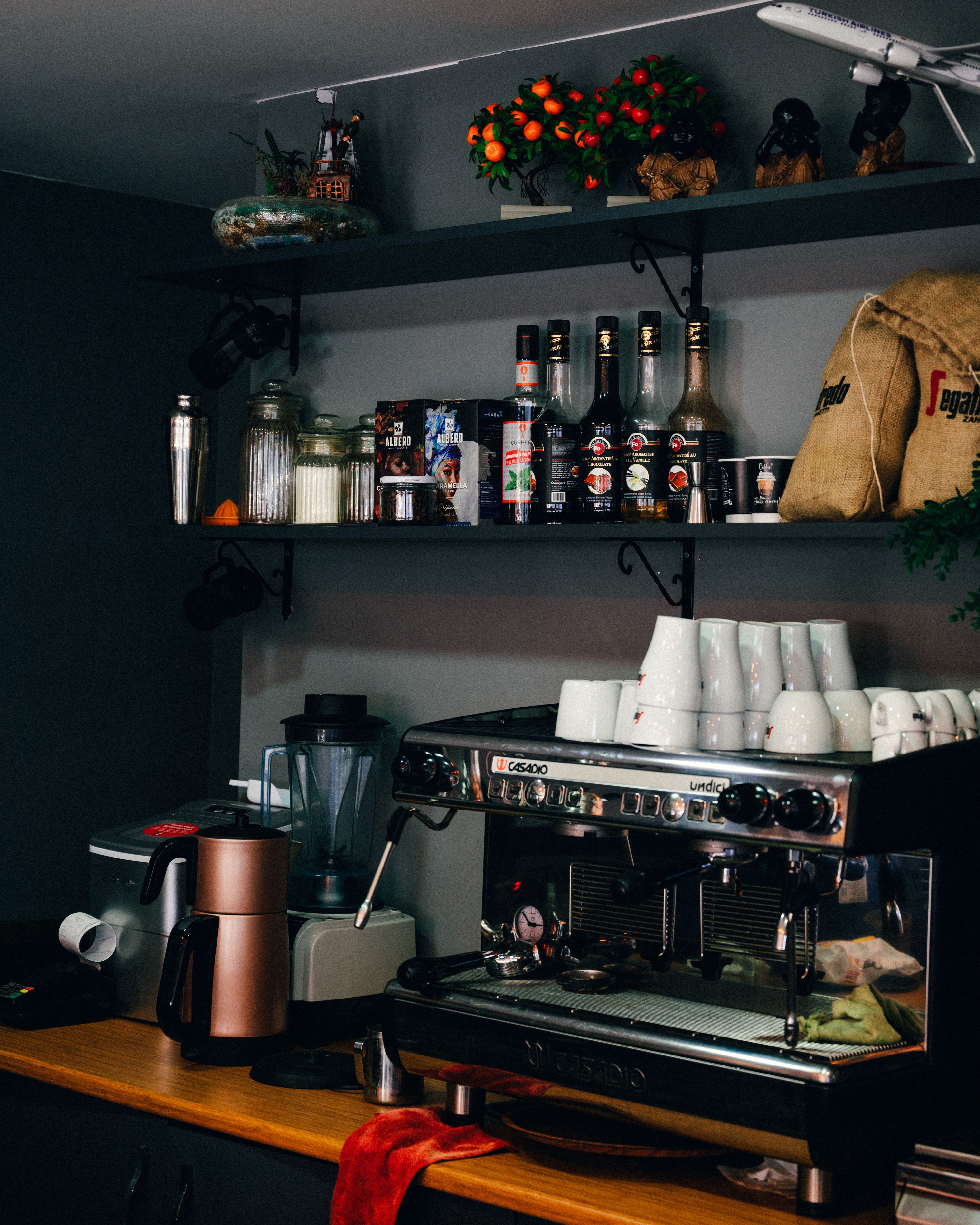A coffee machine is on a shelf in a kitchen · Free Stock Photo