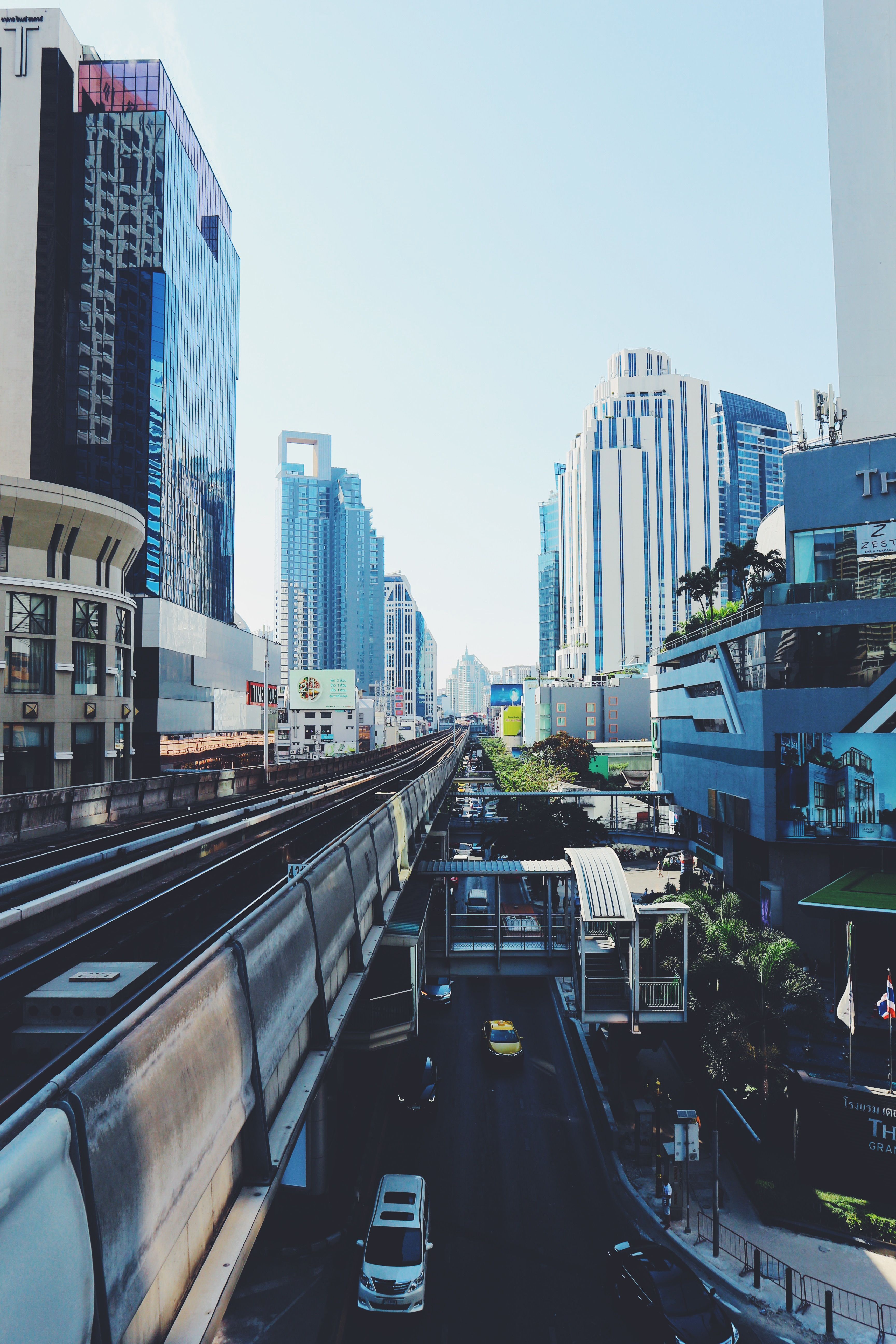 Vehicles on Road Between Buildings · Free Stock Photo