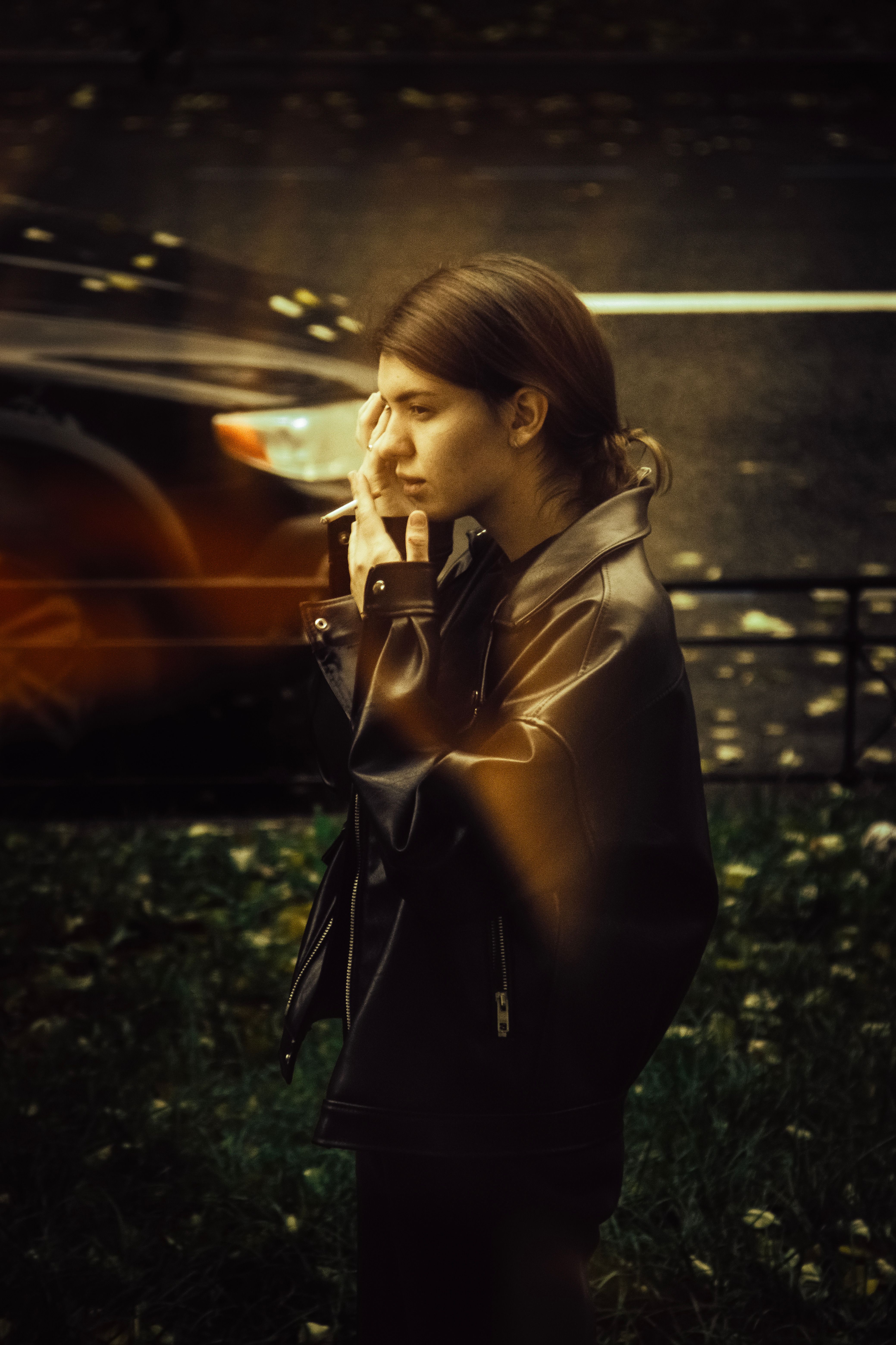 Woman in Leather Jacket Smoking Cigarette · Free Stock Photo
