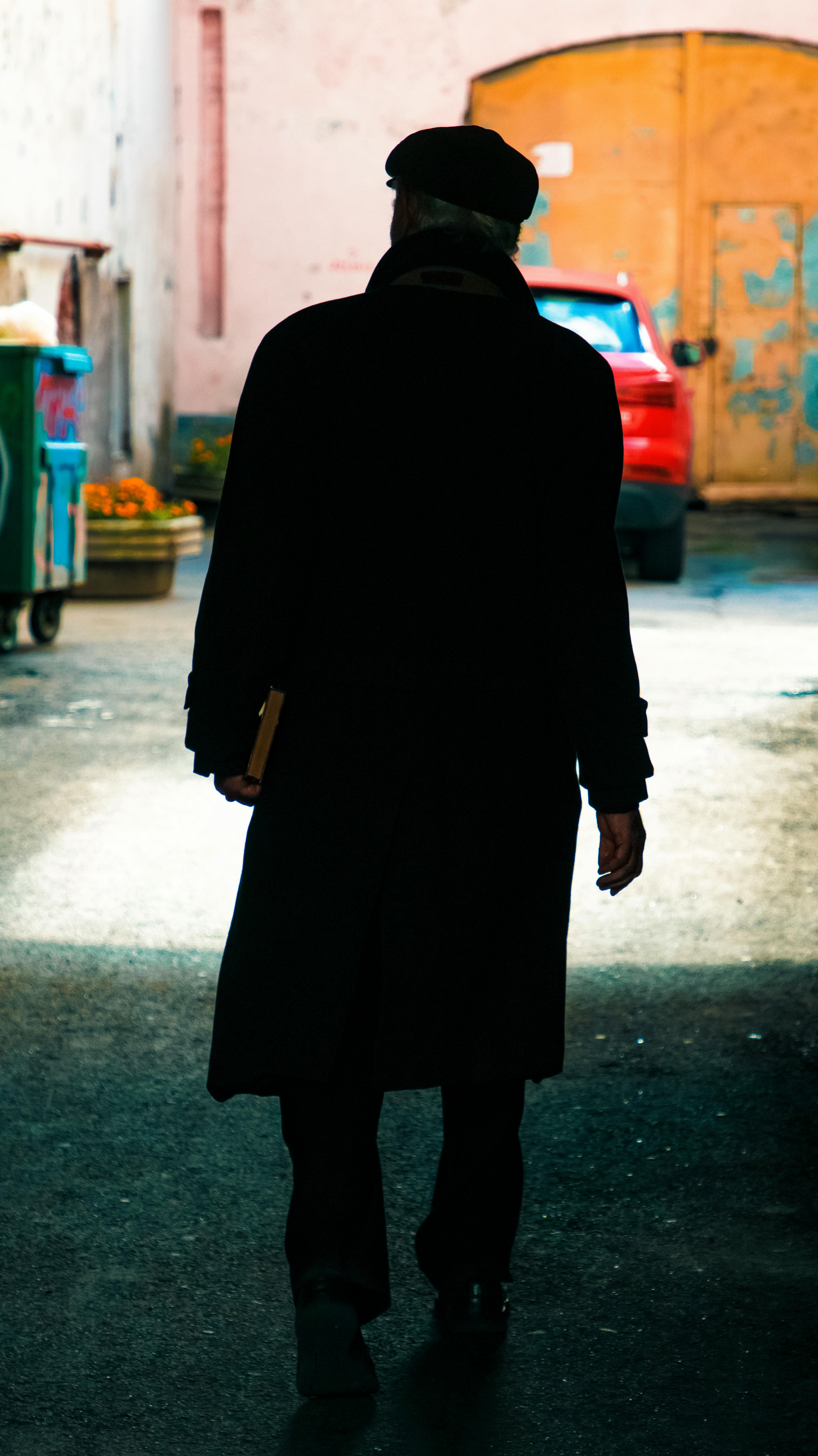 Back View of Man Walking in Shadow · Free Stock Photo