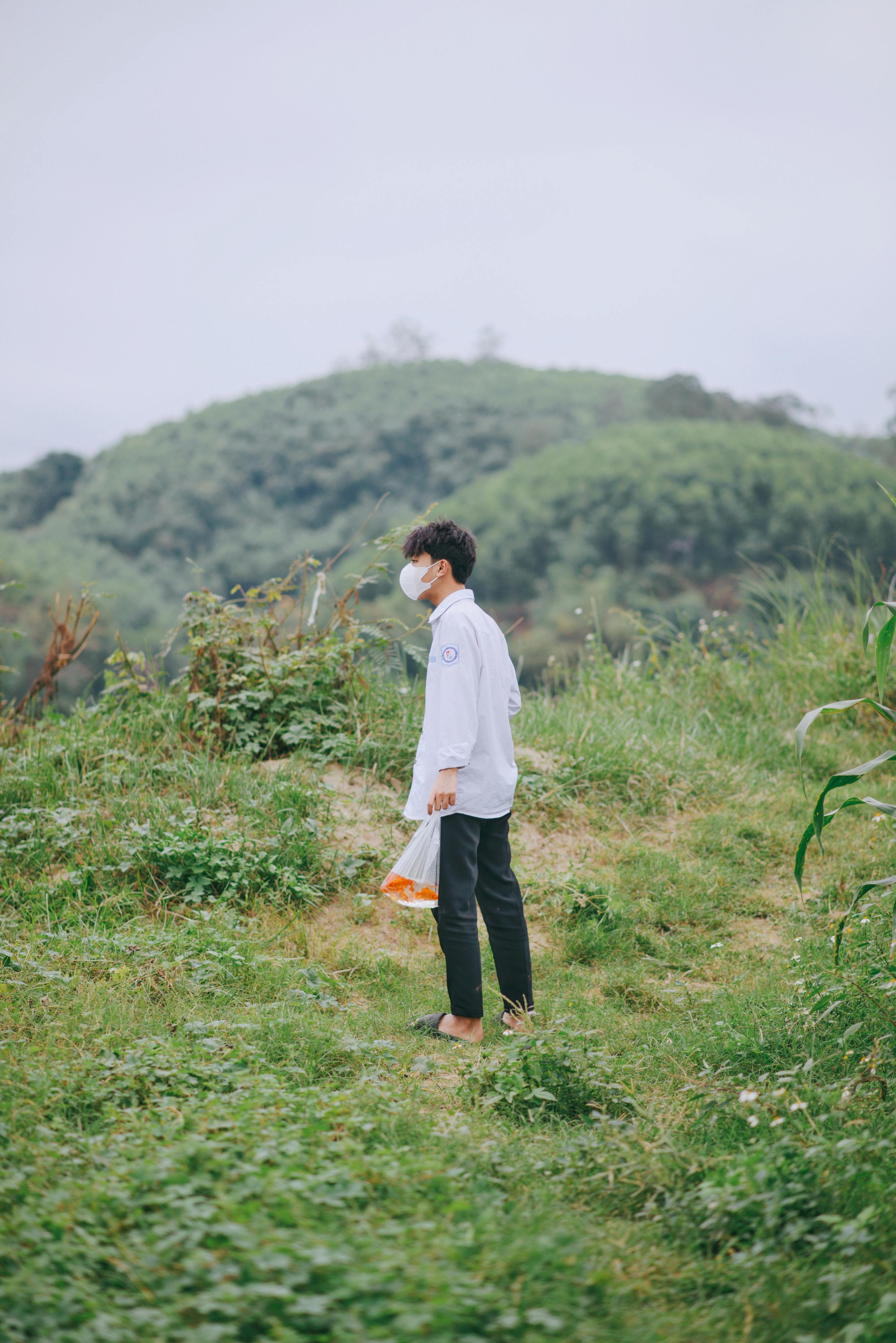 Man with Face Mask on a Field · Free Stock Photo