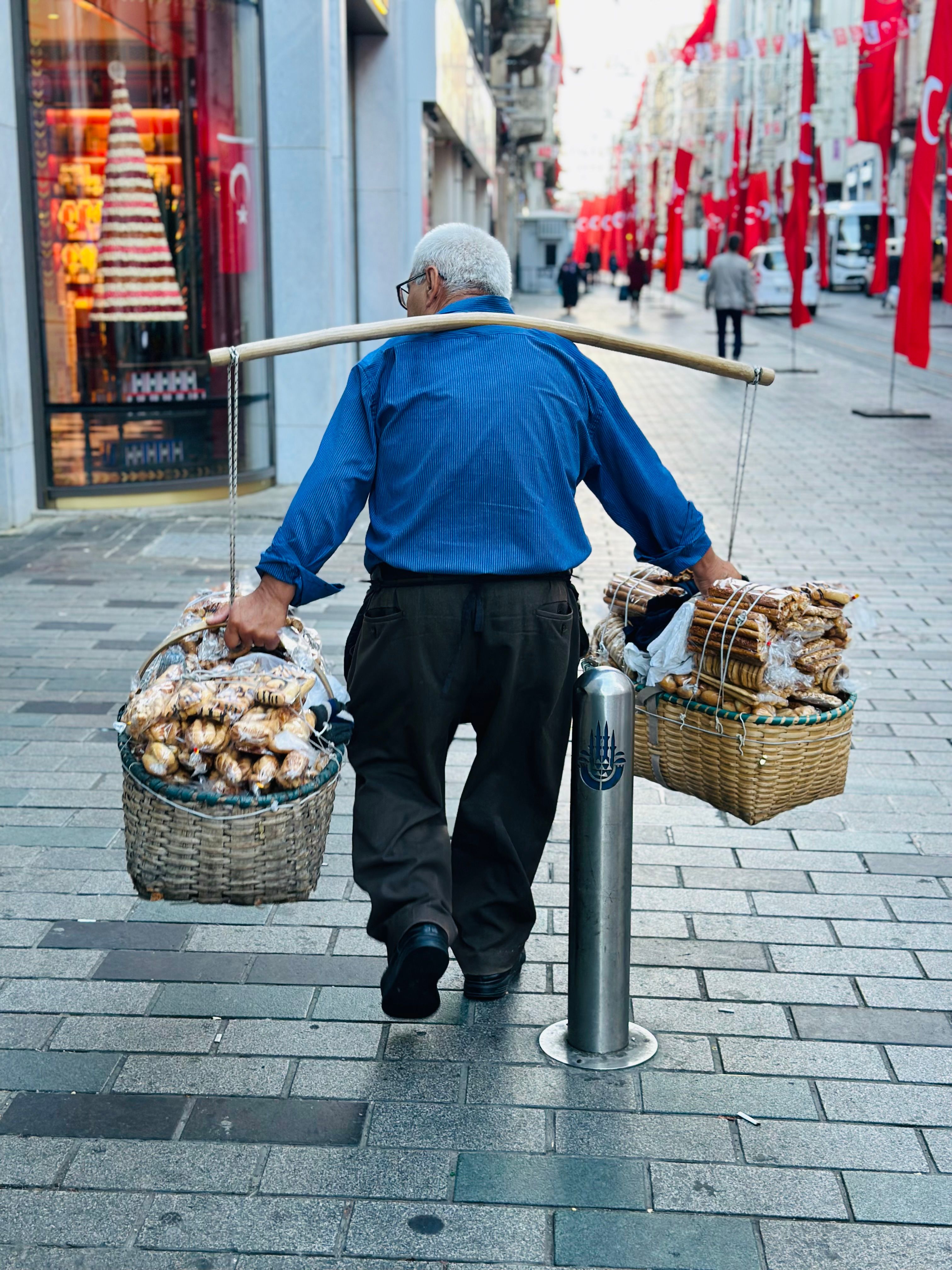 Man Carrying Food Baskets on Street in Turkey · Free Stock Photo