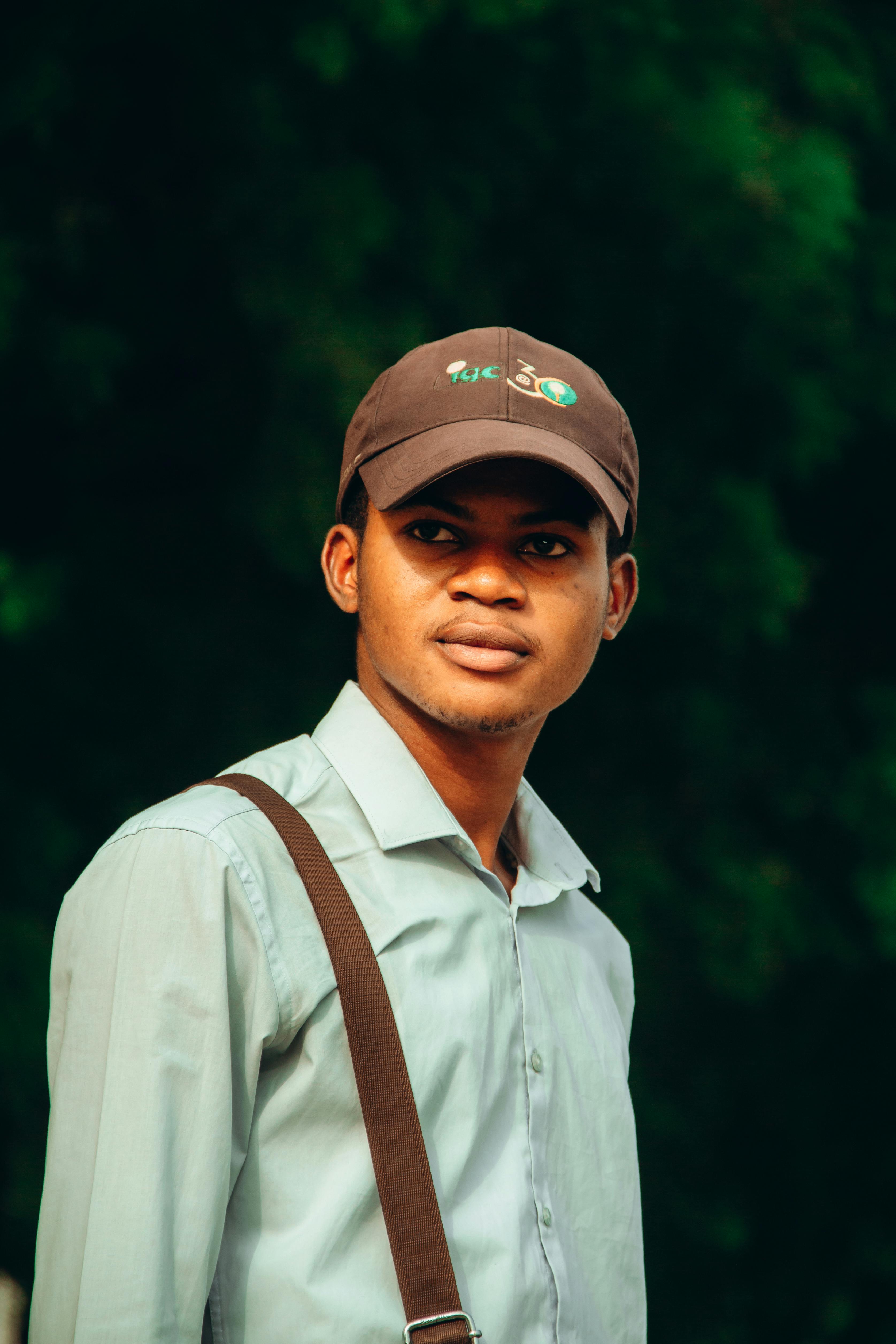 Photo of a Young Man Wearing a Shirt and a Cap · Free Stock Photo