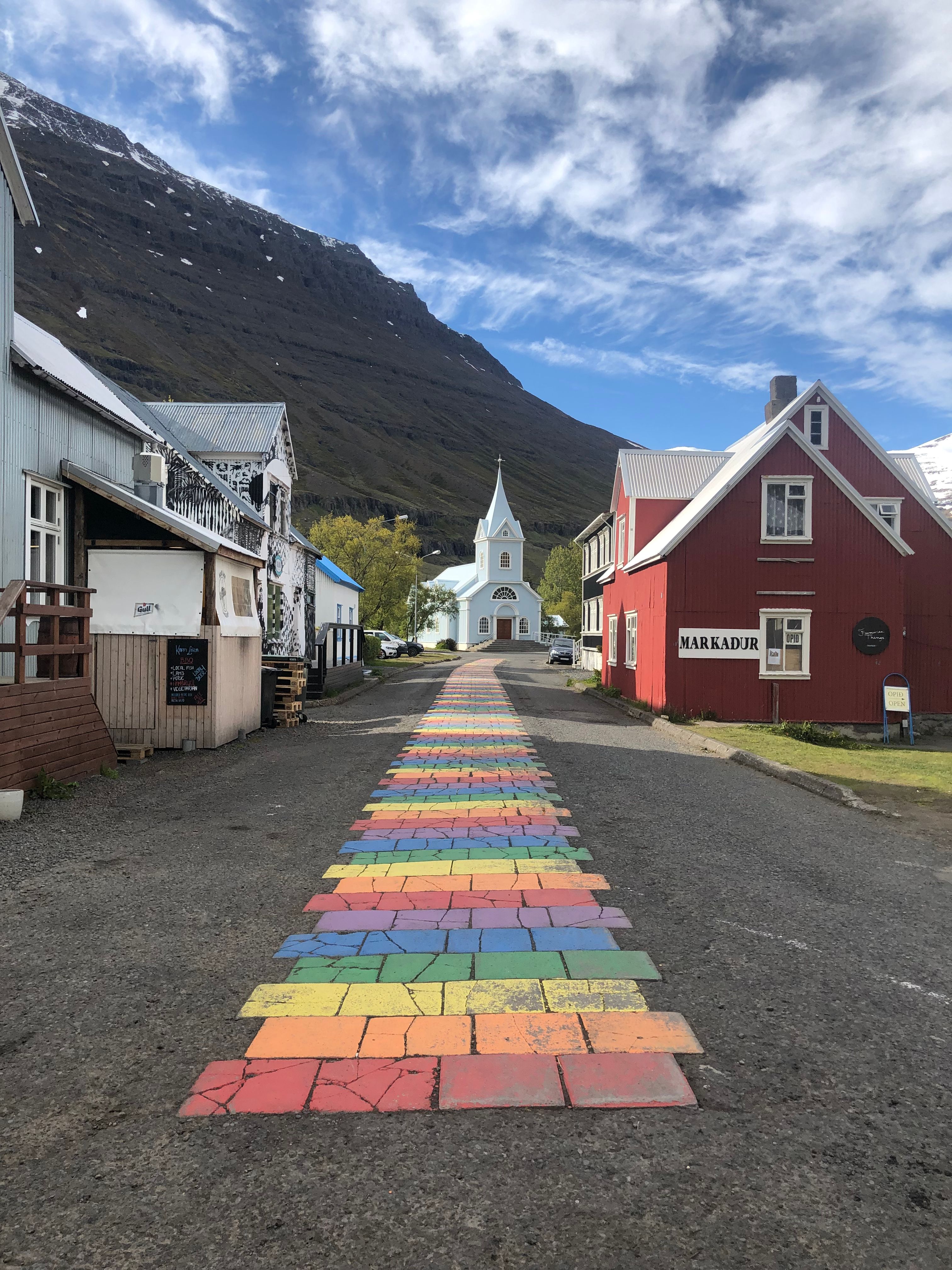Rainbow Pavement towards Church in Village in Iceland · Free Stock Photo