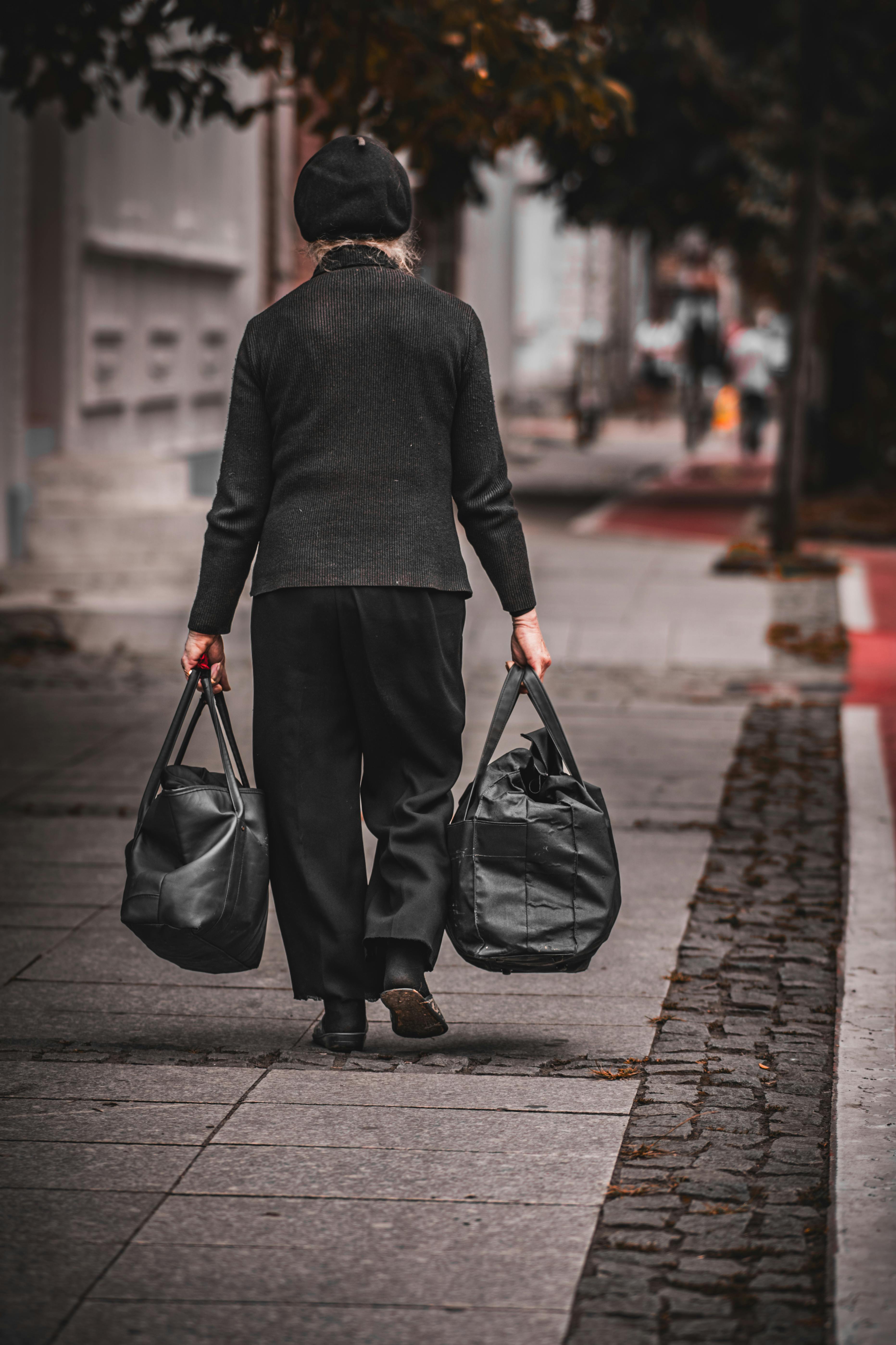 Woman Carrying Bags on Sidewalk · Free Stock Photo