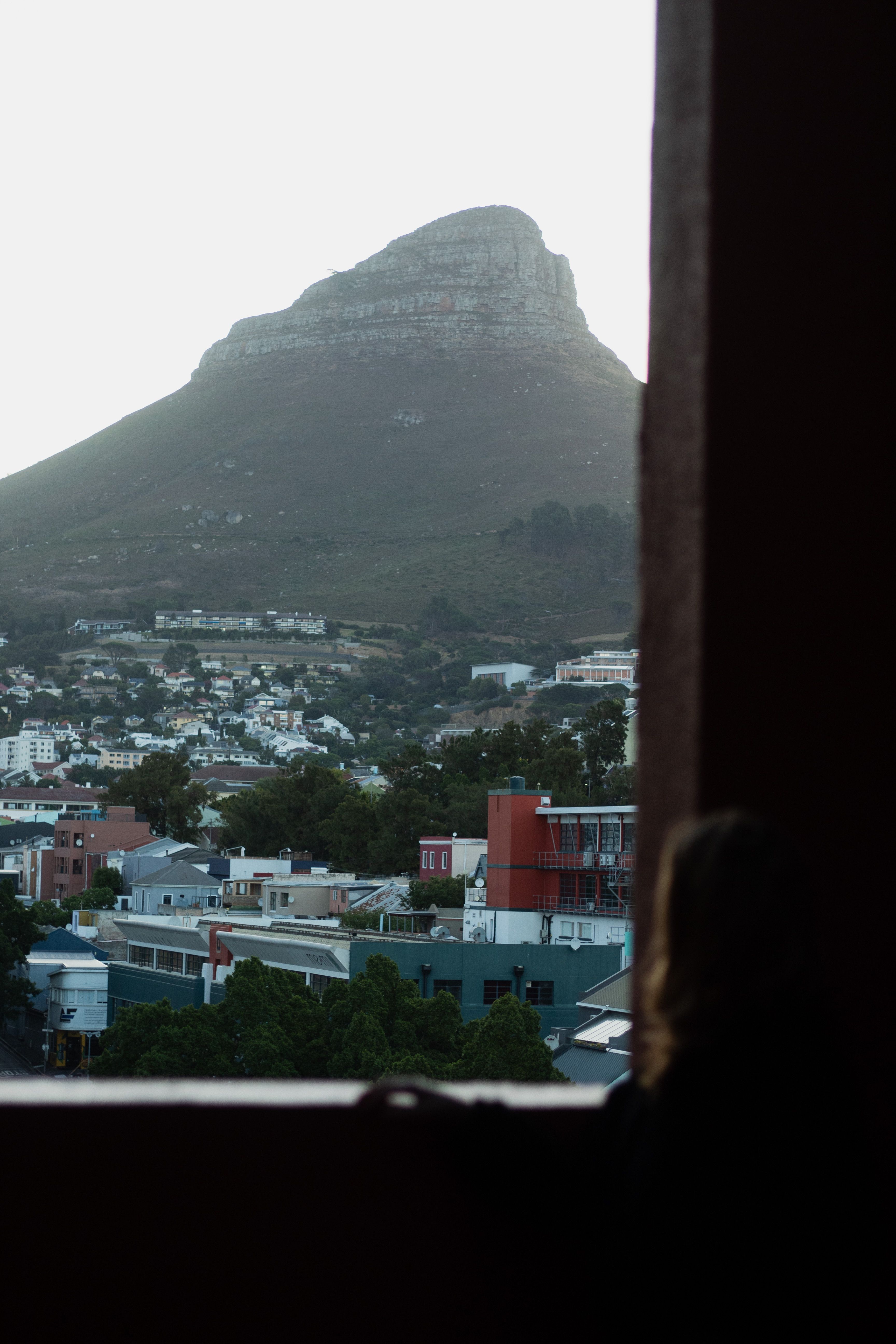 Beautiful Town and a Mountain Seen from a Window · Free Stock Photo