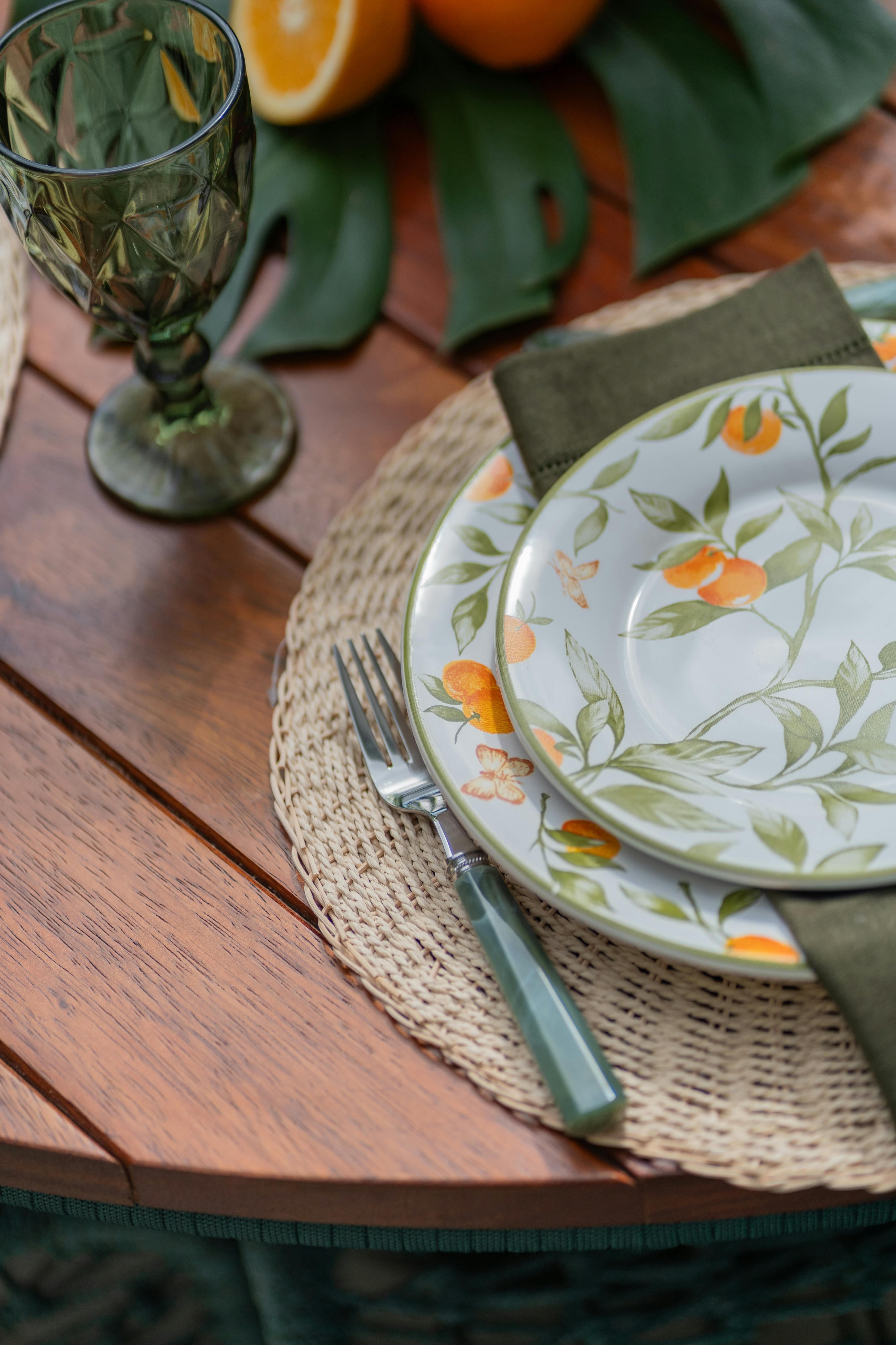 Orange Design Plates with Cutlery on a Wooden Table · Free Stock Photo
