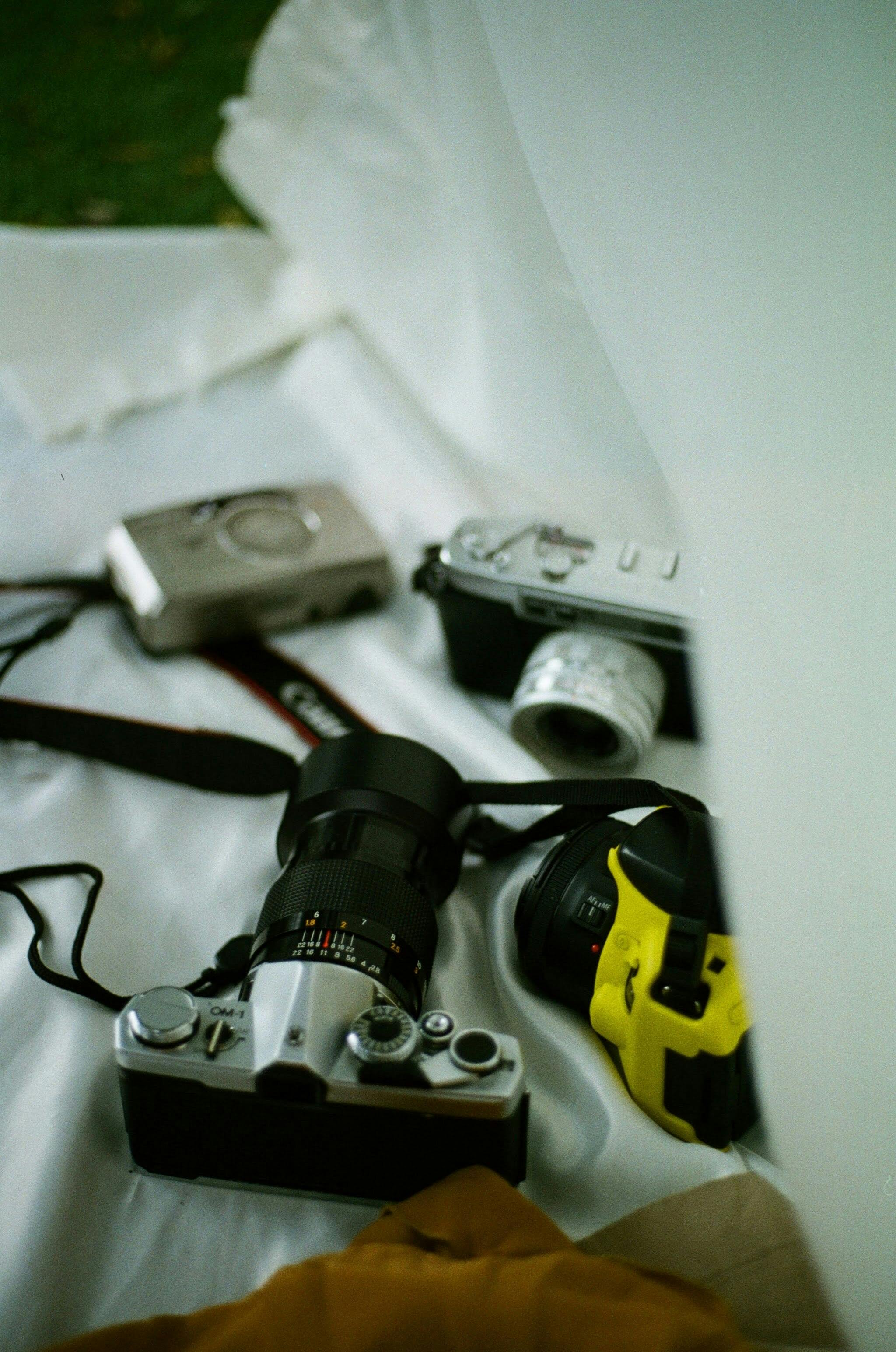 Wide Range of Cameras on White Sheet · Free Stock Photo