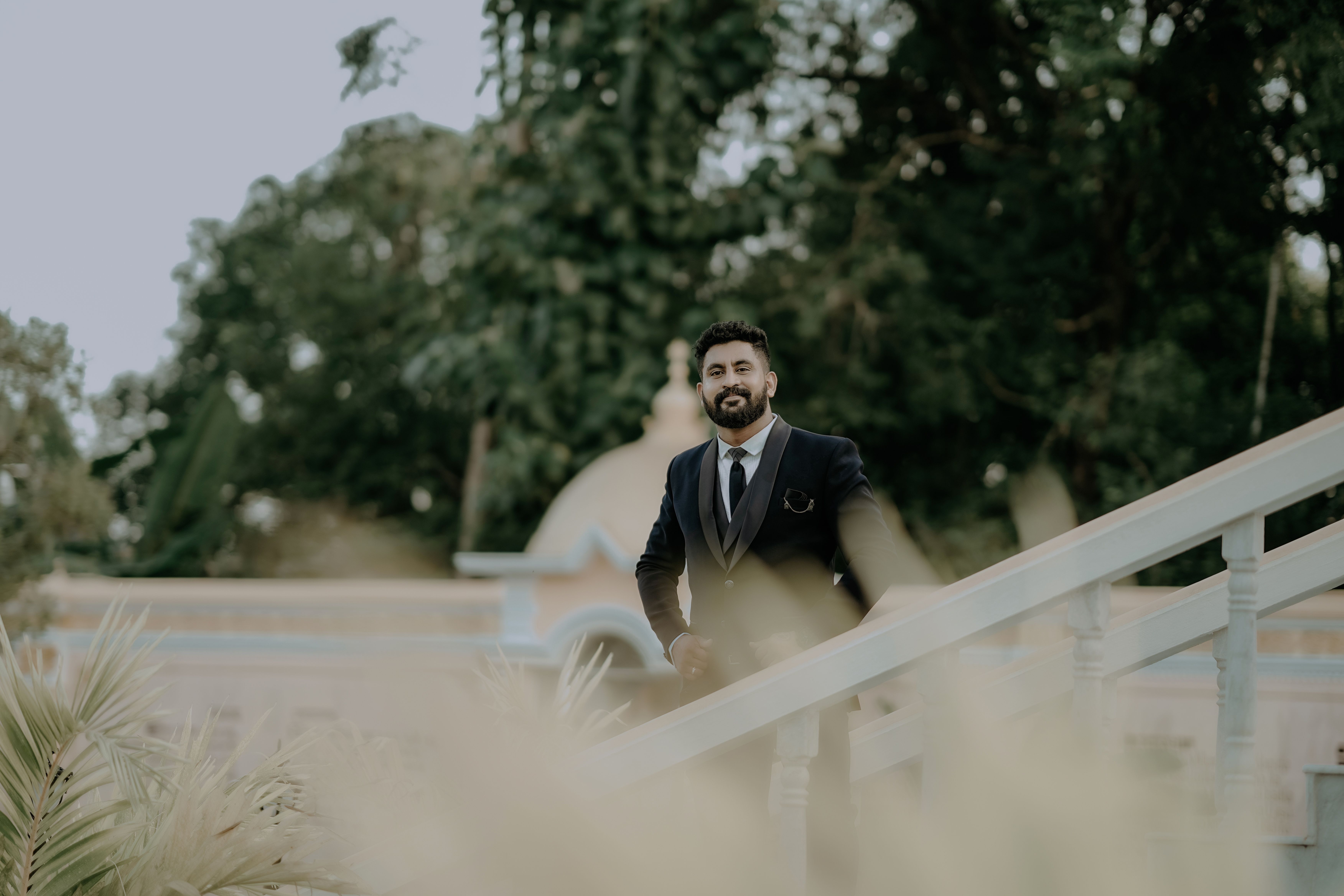 Man in Black Suit Standing Next to Barrier · Free Stock Photo