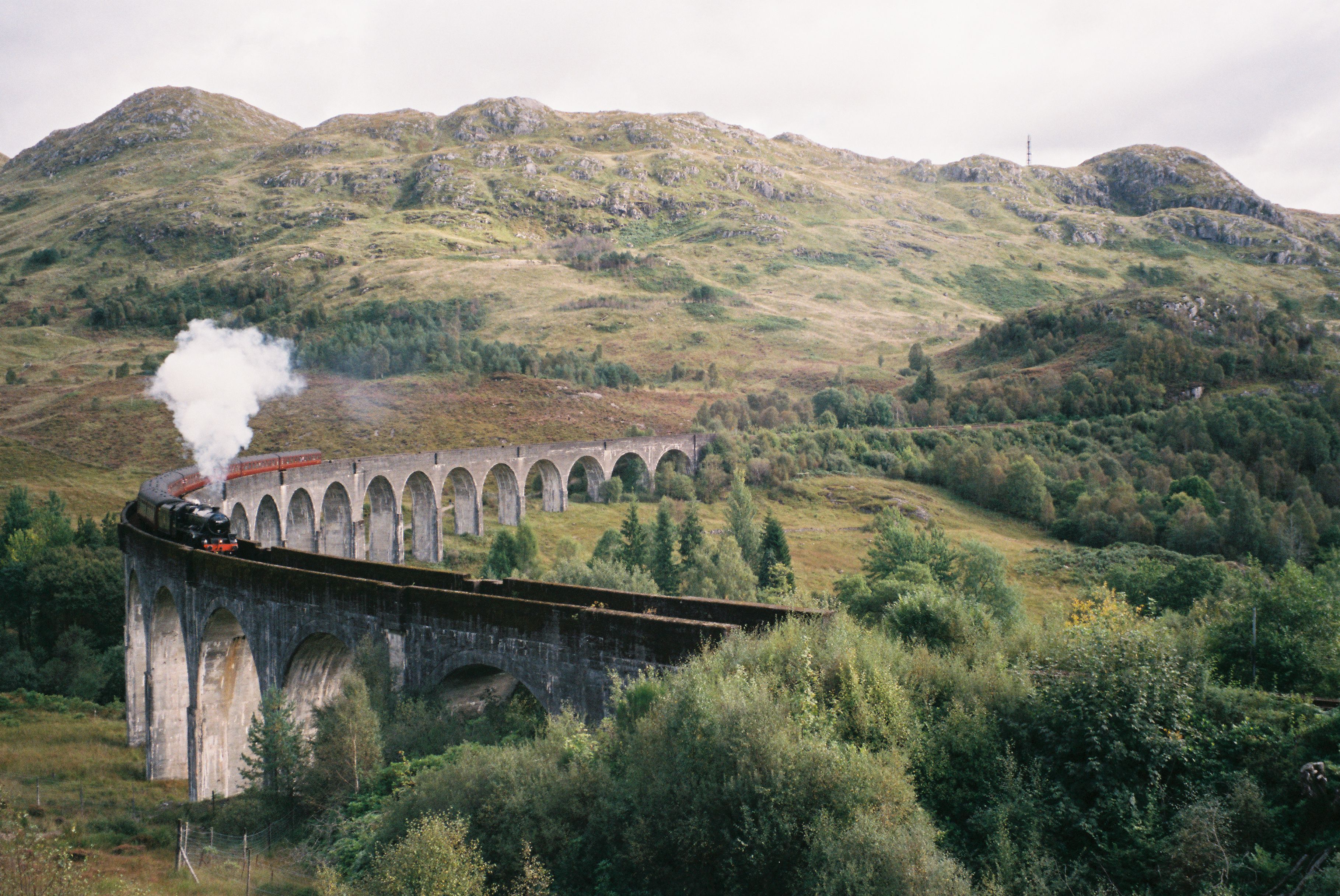 Mountain Landscape with Train on Viaduct · Free Stock Photo