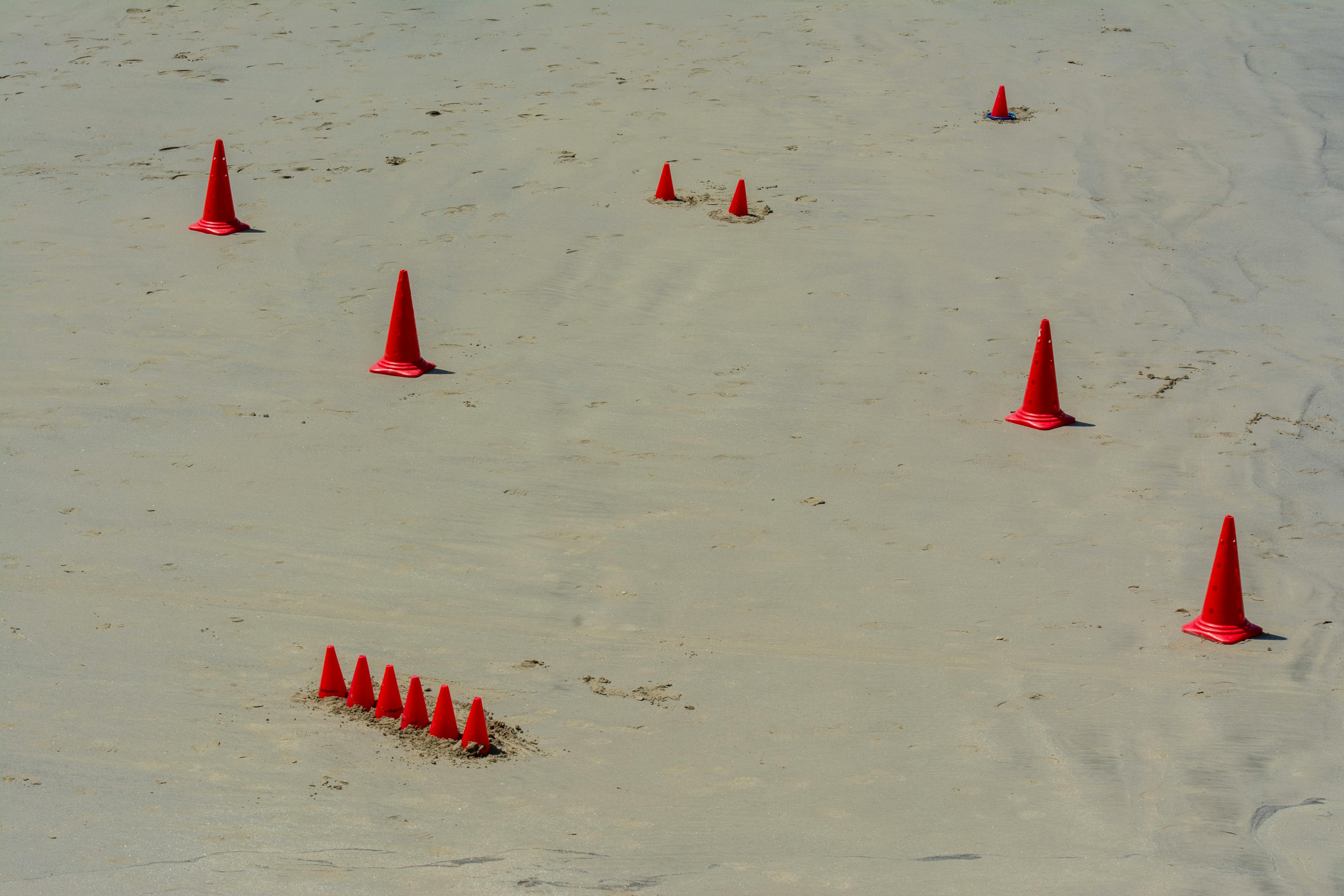 Photo of Red Cones Standing on a Beach · Free Stock Photo