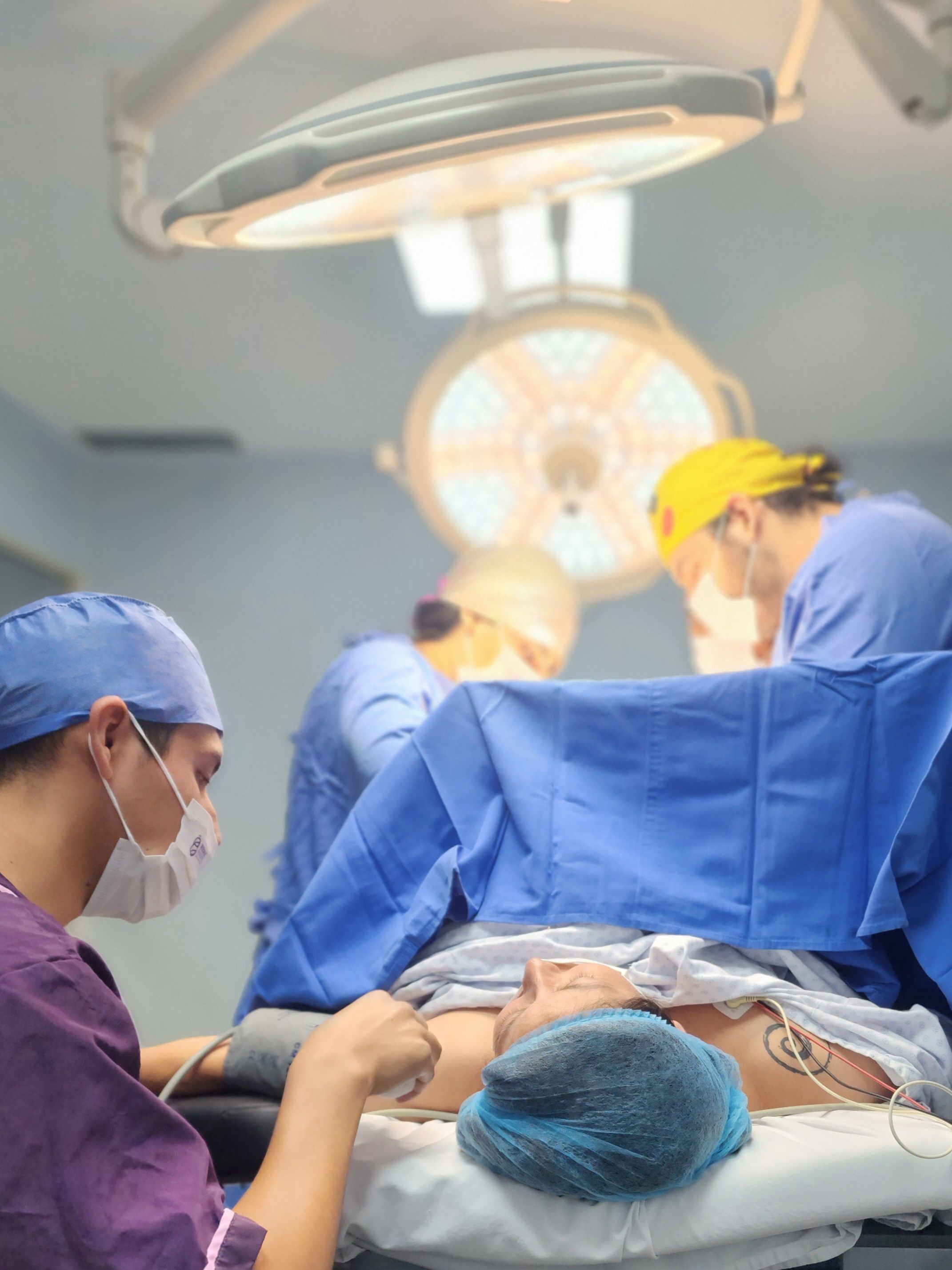 Patient and Doctors in Operating Room · Free Stock Photo