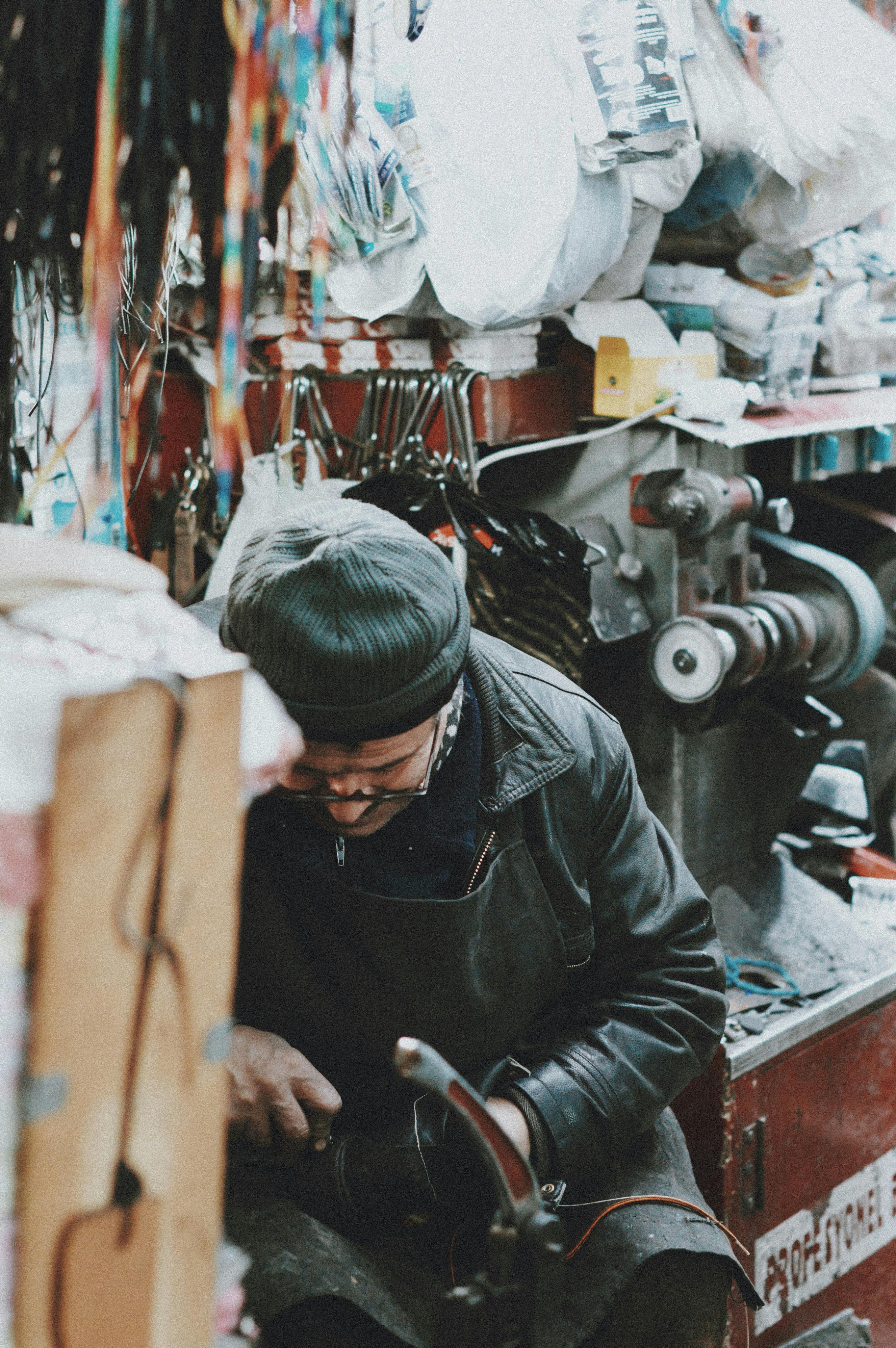 Shoemaker Sitting and Working · Free Stock Photo