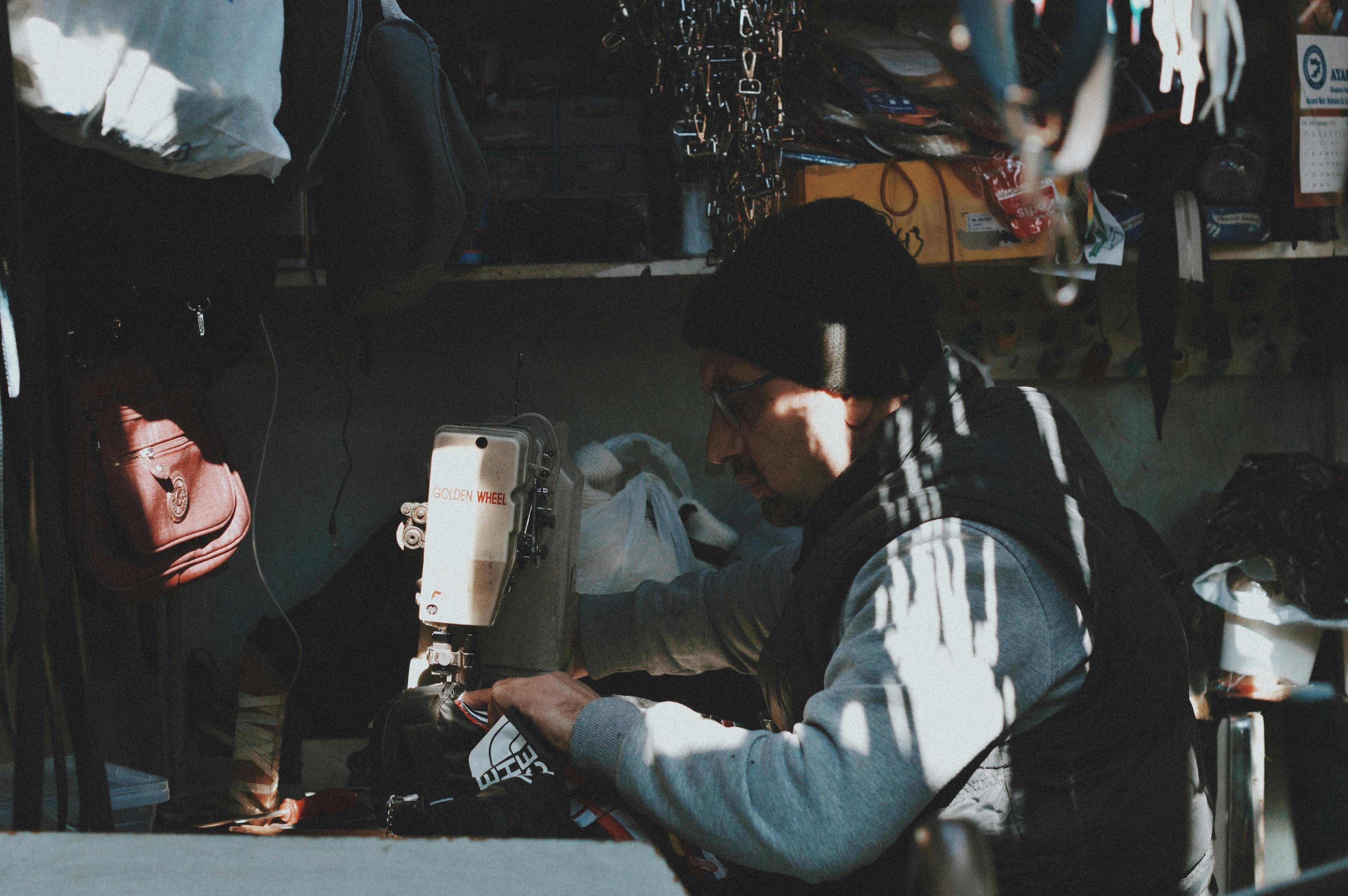 Tailor Working on Sewing Machine · Free Stock Photo