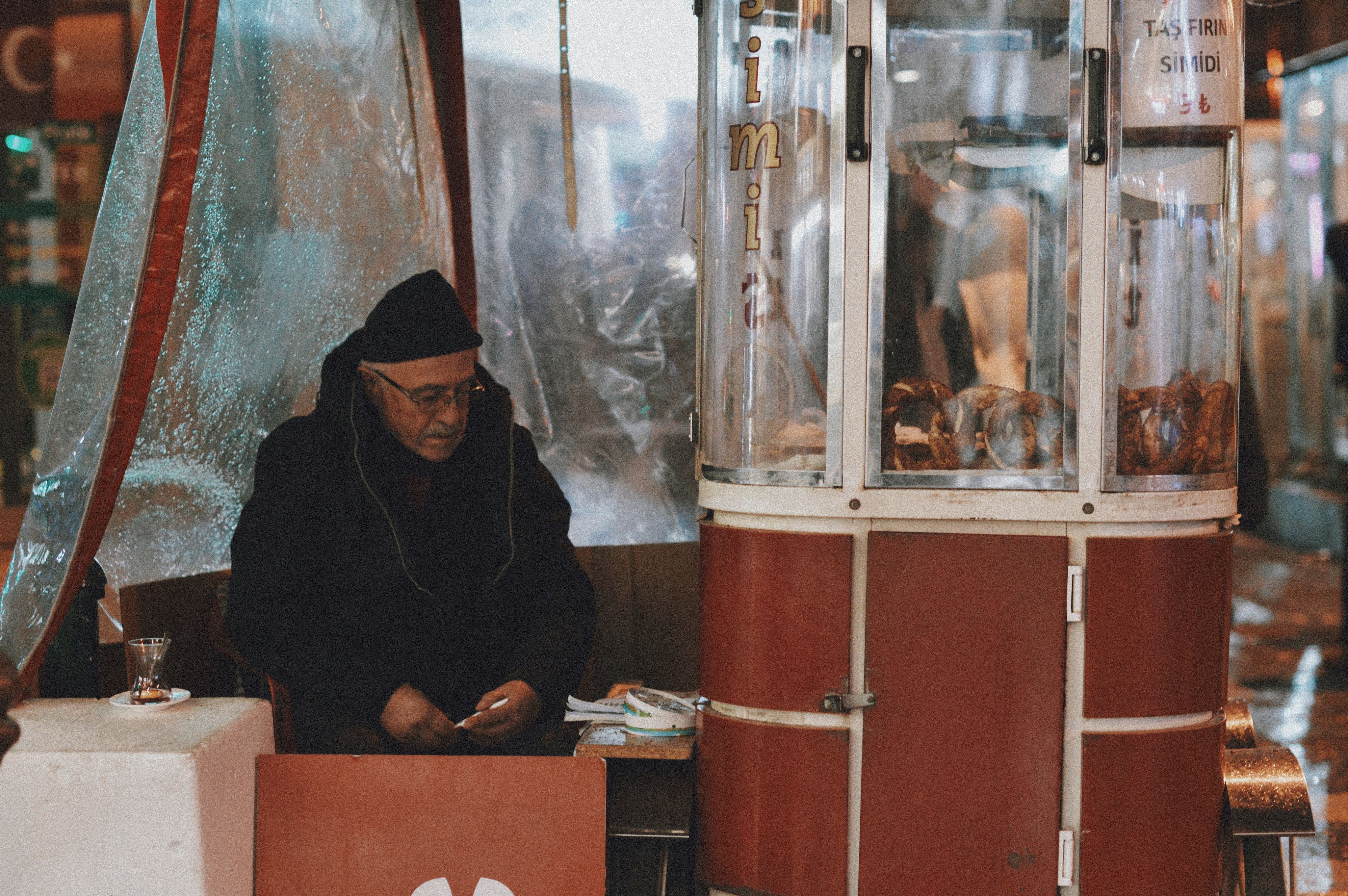 Elderly Man Working as Merchant at Market · Free Stock Photo