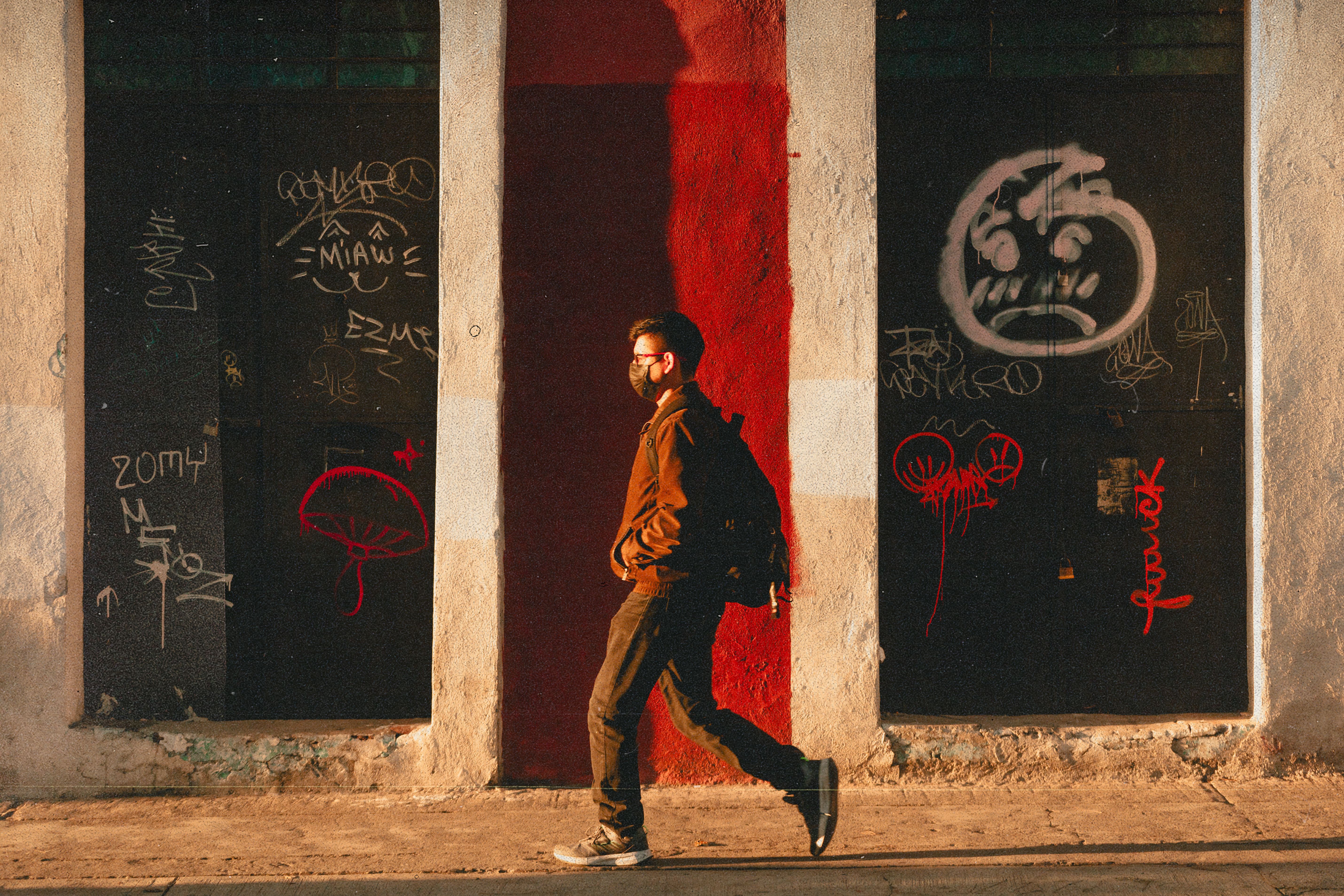 Man Walking near Wall · Free Stock Photo