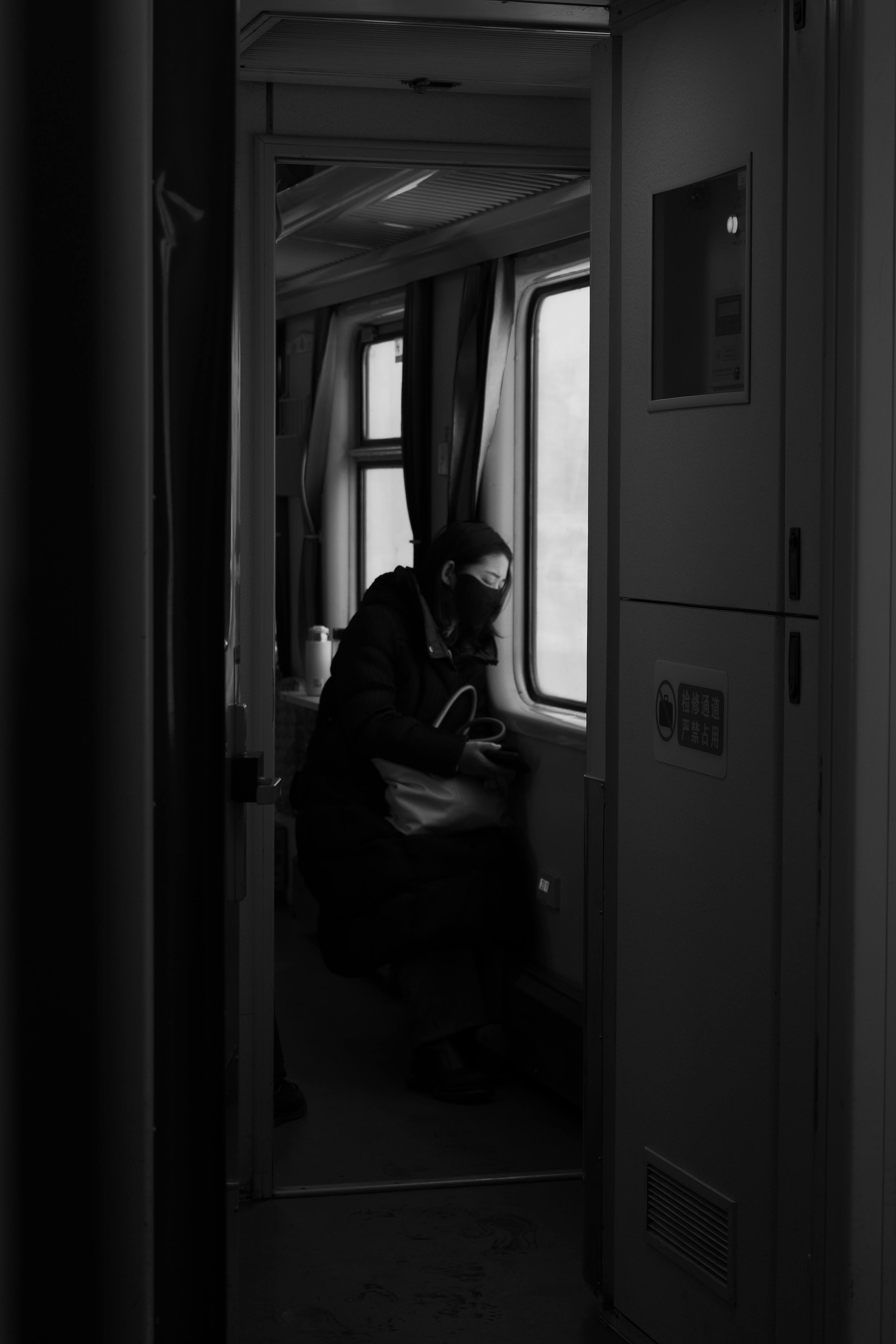 Two Passengers Sitting on a Train Facing Each Other · Free Stock Photo