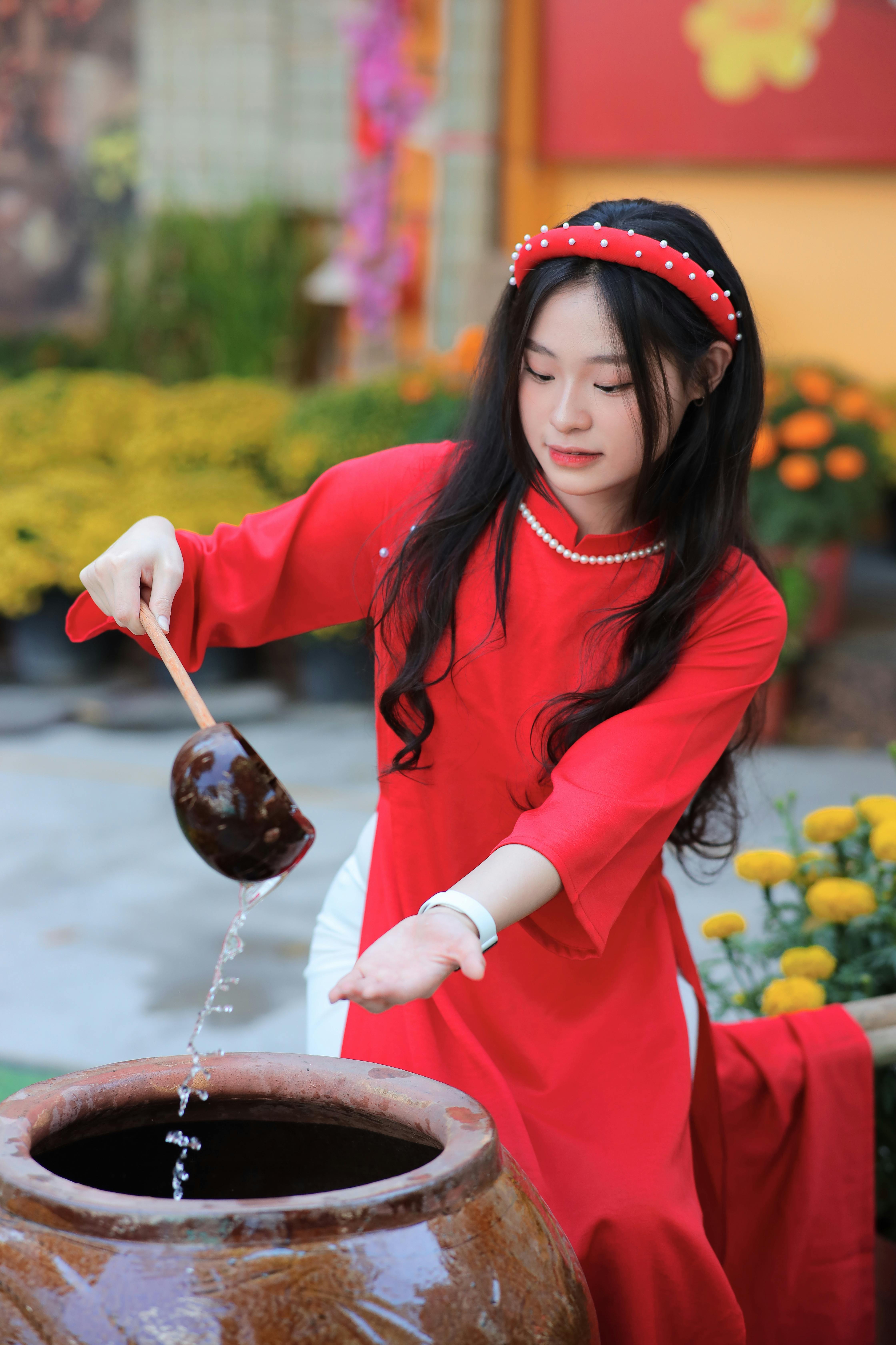 Woman in Red, Traditional Clothing Sitting with Cauldron with Water ...