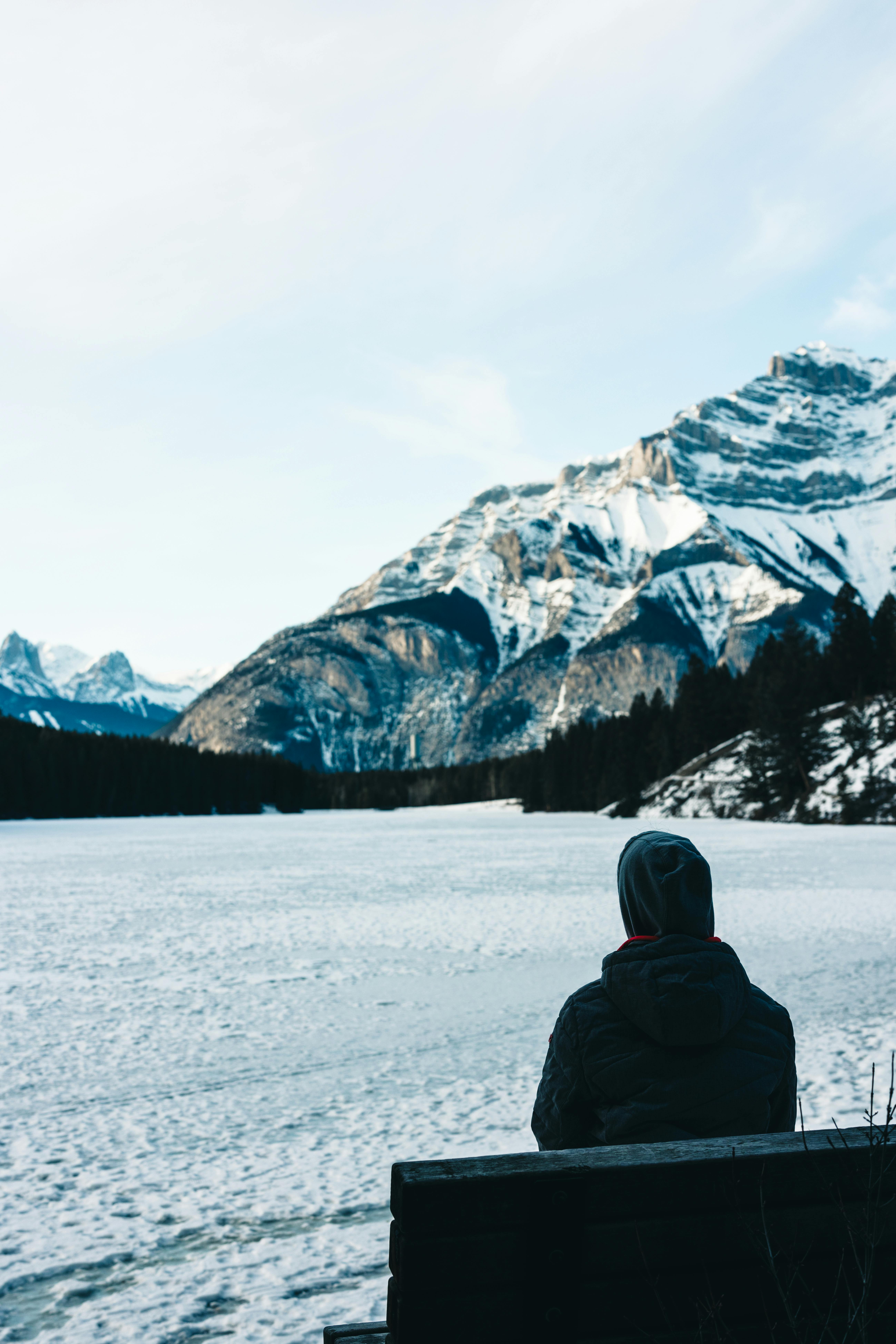 Person Relaxing in Snowy Mountains · Free Stock Photo